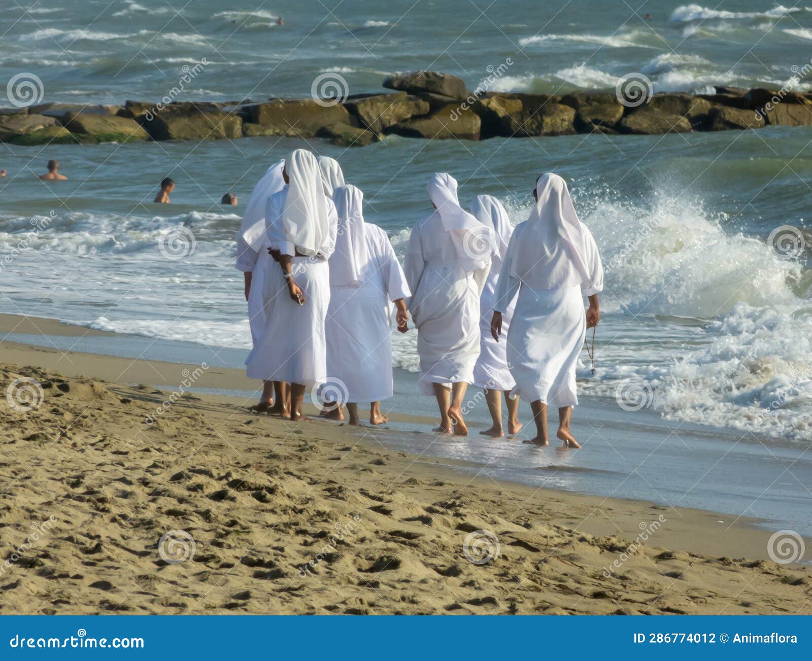Nuns Walk in the Sand on the Beach 01 Stock Photo - Image of dress ...