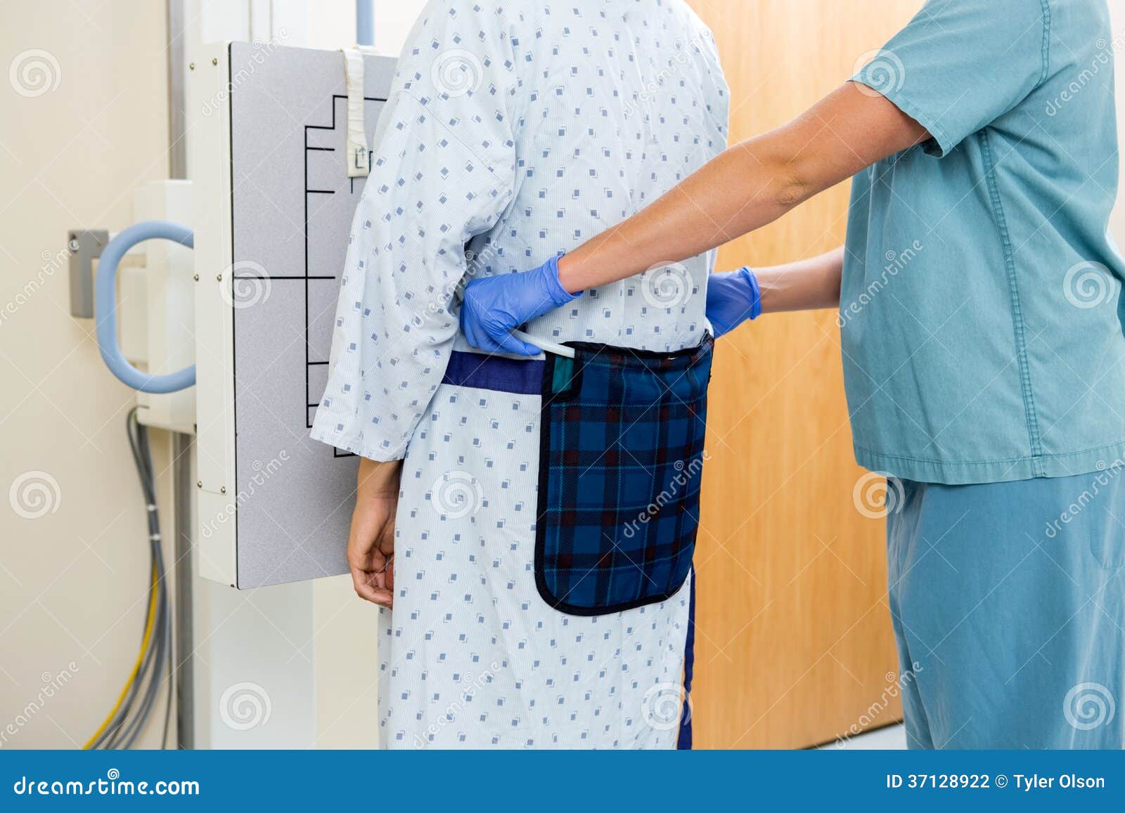 Nurse Adjusting Apron on Patient before Xray Stock Photo - Image of ...