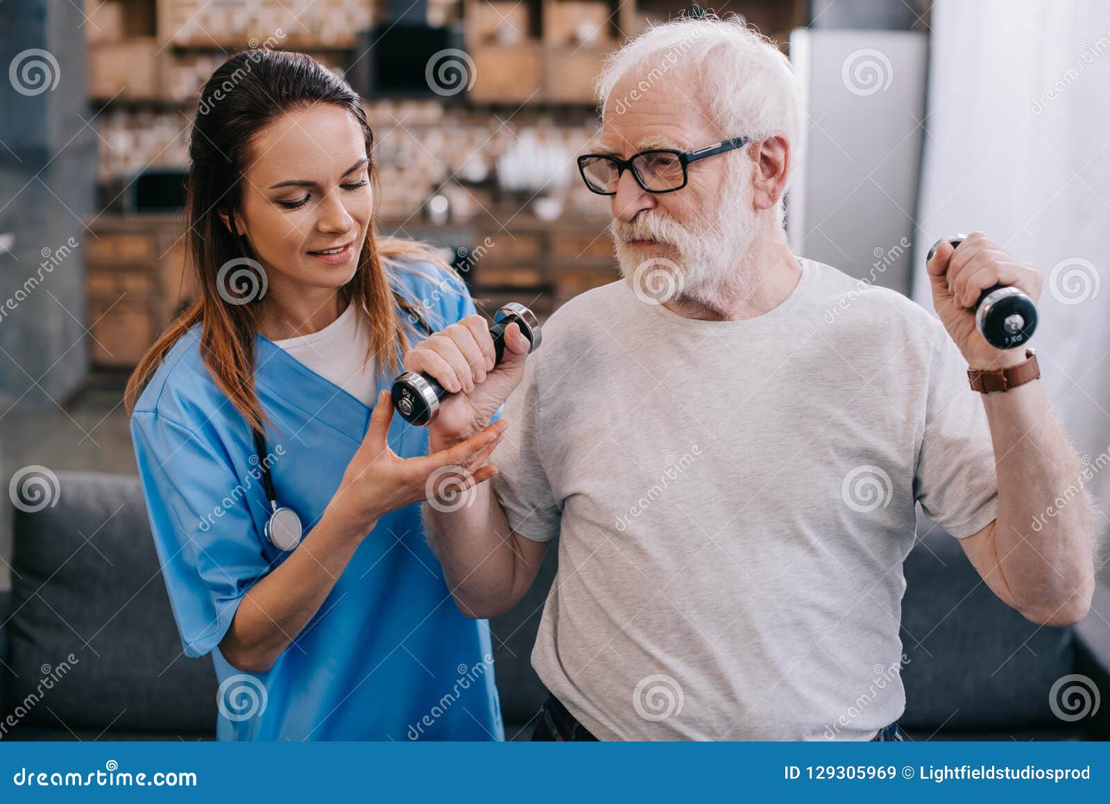 Nurse Assisting Senior Man Exercising Stock Image - Image of ...