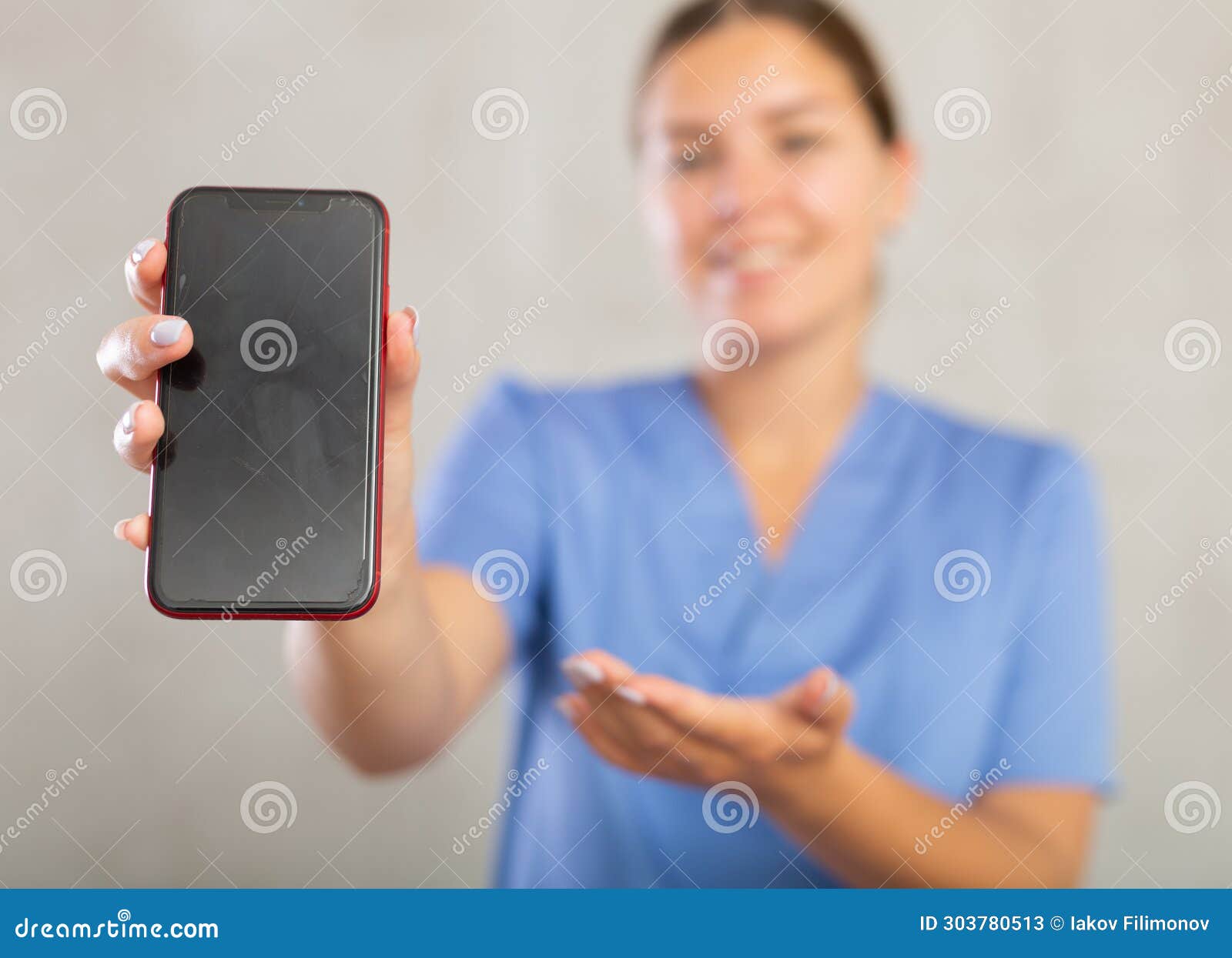 Nurse In Blue Uniform Recommending Mobile Medical App Stretching Out