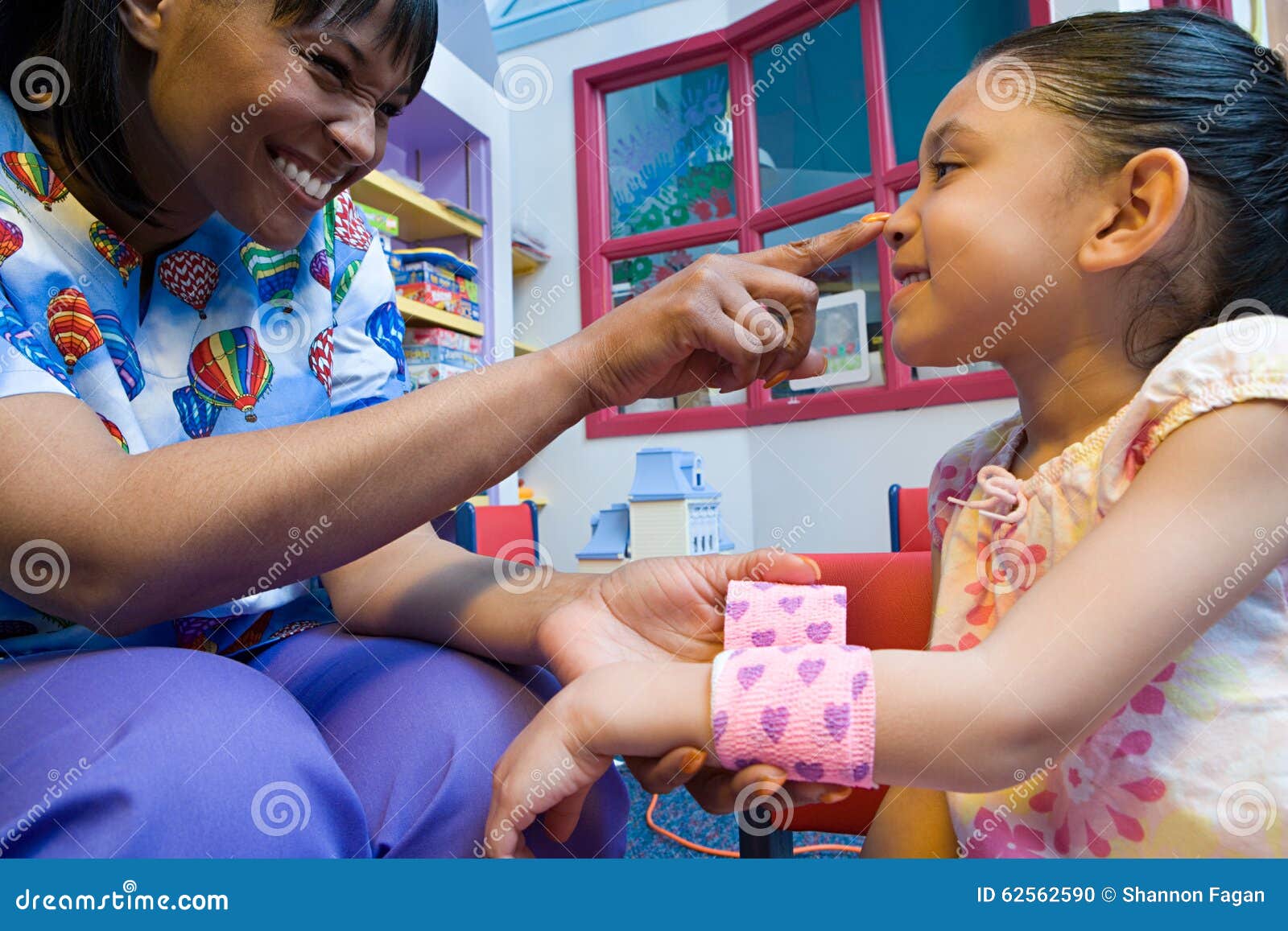 Nurse caring for girl stock photo. Image of ethnicity - 62562590