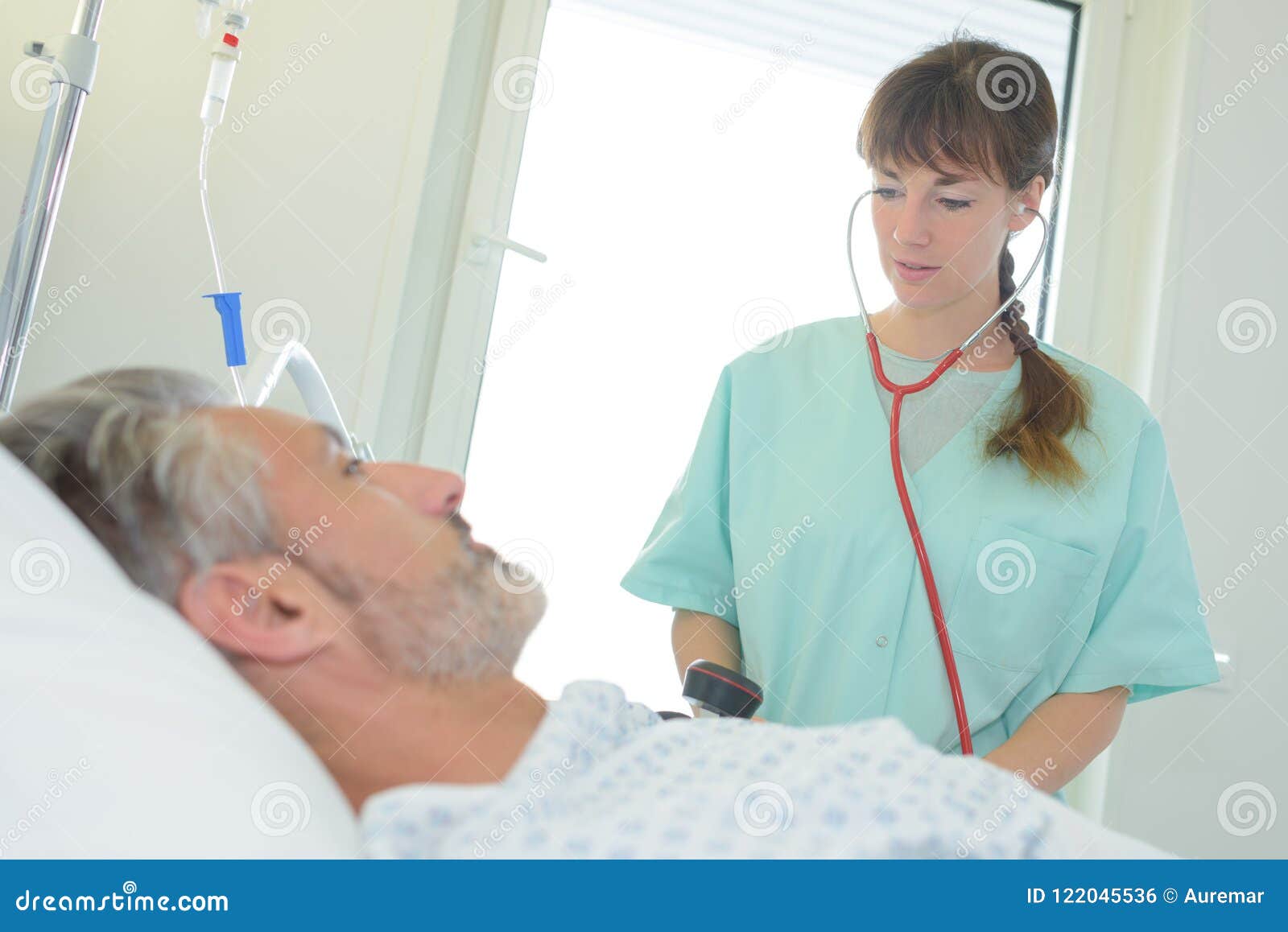 Nurse checking the patient stock photo. Image of lying - 122045536