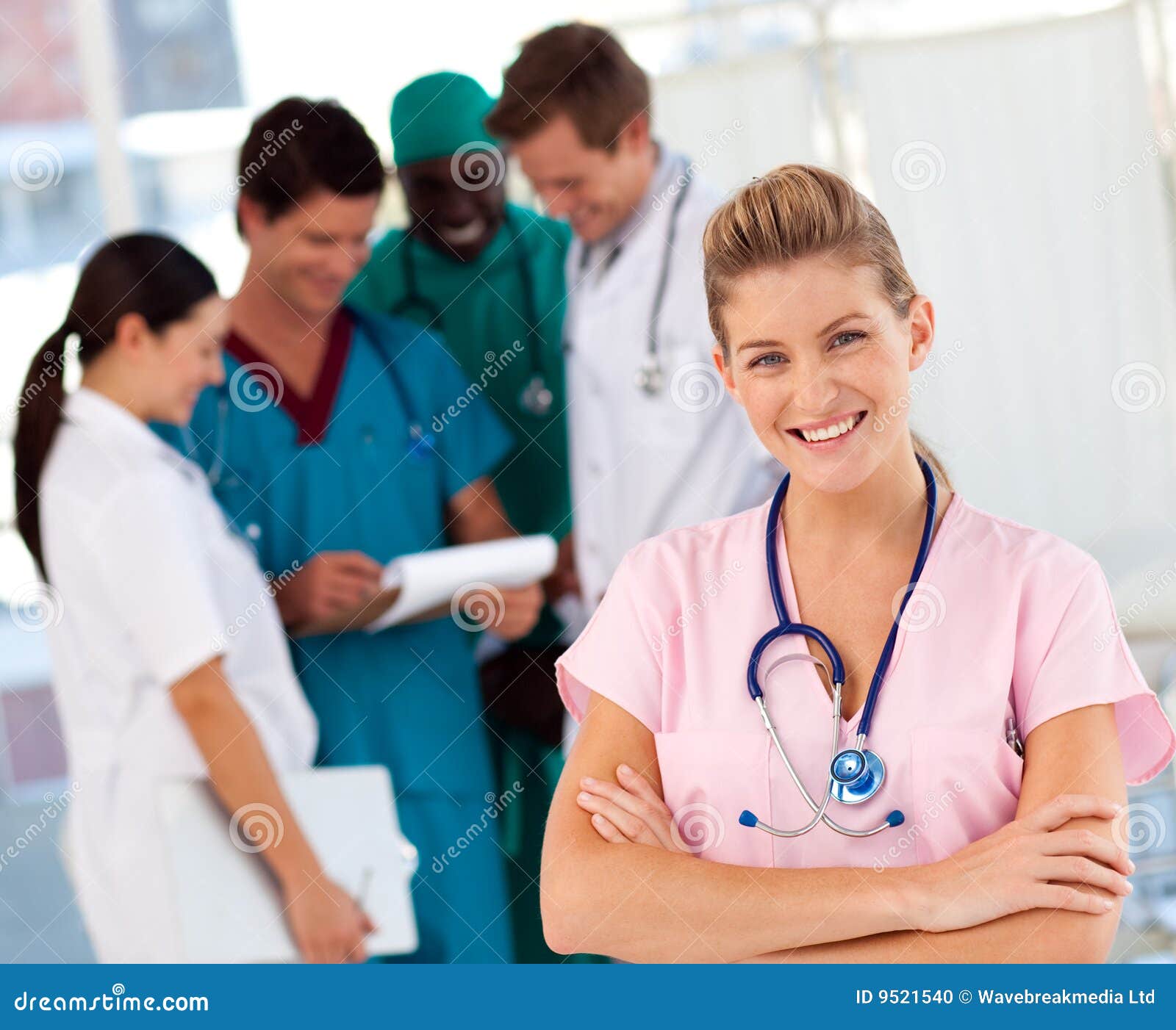 Nurse with Doctors in the Background Stock Photo - Image of happy ...
