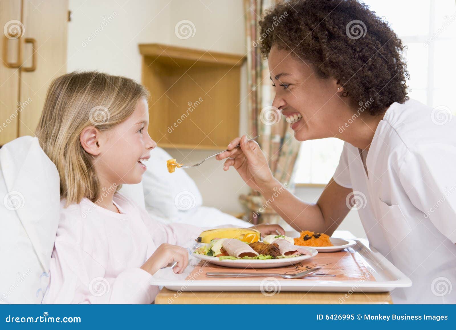 Nurse Feeding Young Girl stock image. Image of child, eating - 6426995