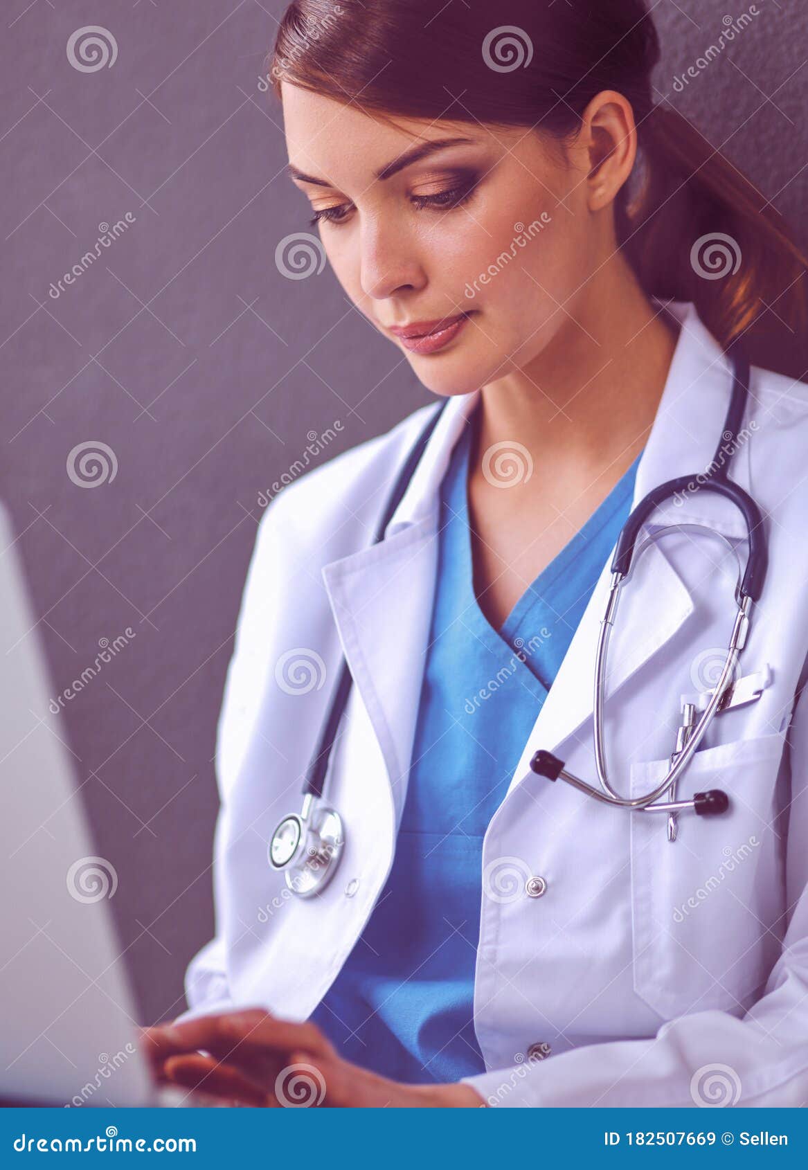 Nurse Holding Folder and Taking Notes - Sitting on Grey Background ...