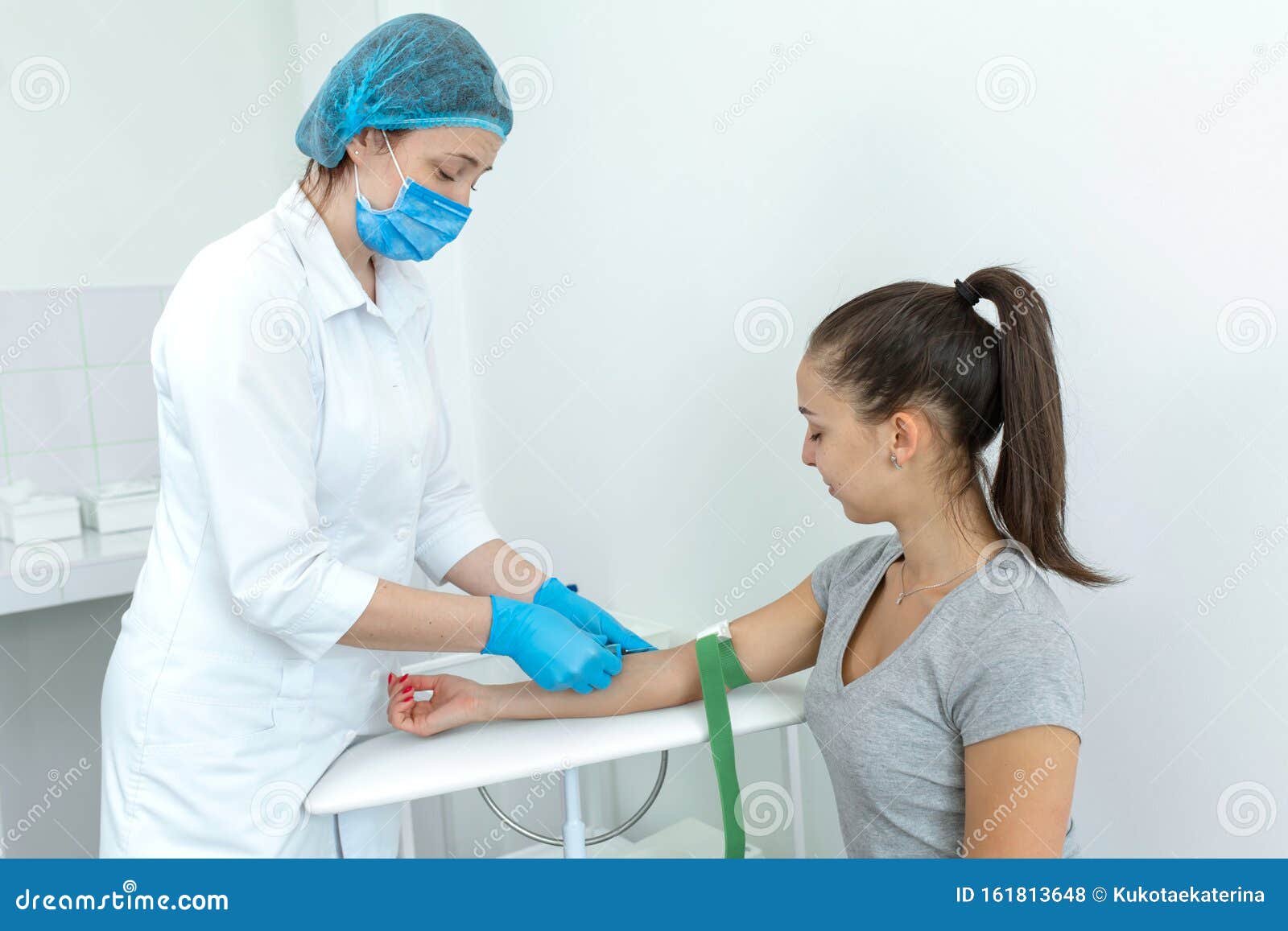 A Nurse Inserts a Needle into a Vein on a Patients Arm. Blood Sampling ...