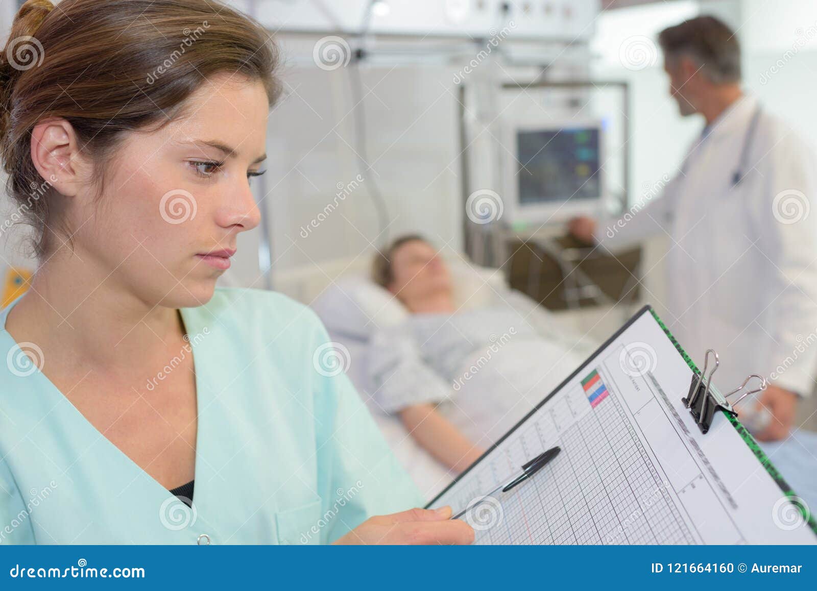 Nurse Looking at Chart on Clipboard Stock Photo - Image of hospital ...