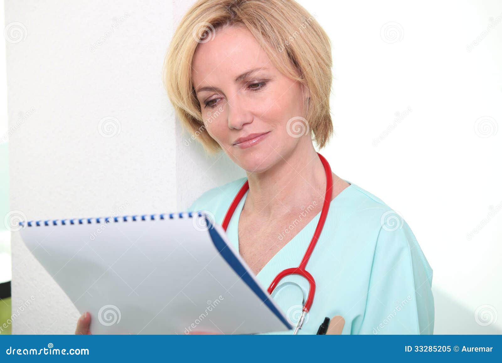 Nurse looking at chart stock image. Image of happy, healthcare - 33285205