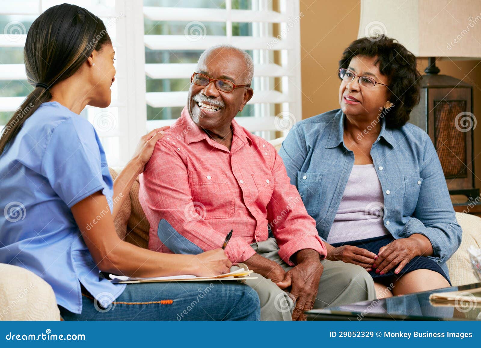 Nurse Making Notes during Home Visit with Senior Couple Stock Image ...