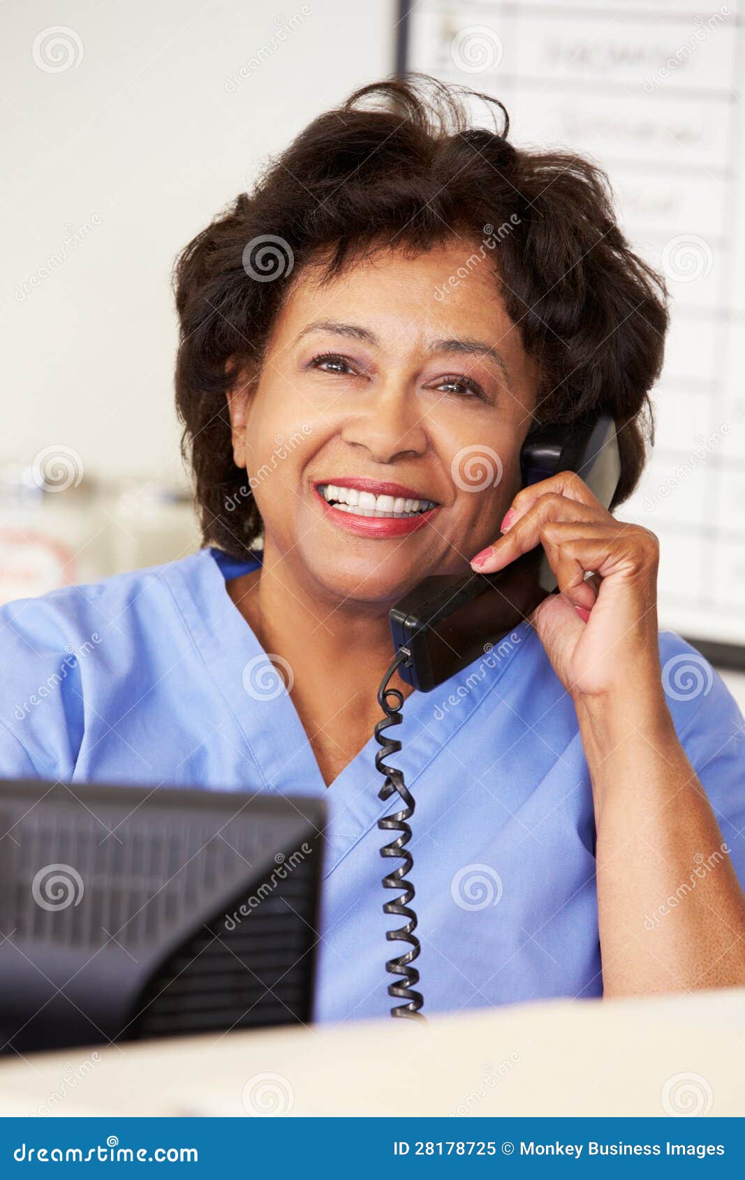 Nurse Making Phone Call at Nurses Station Stock Image - Image of ...