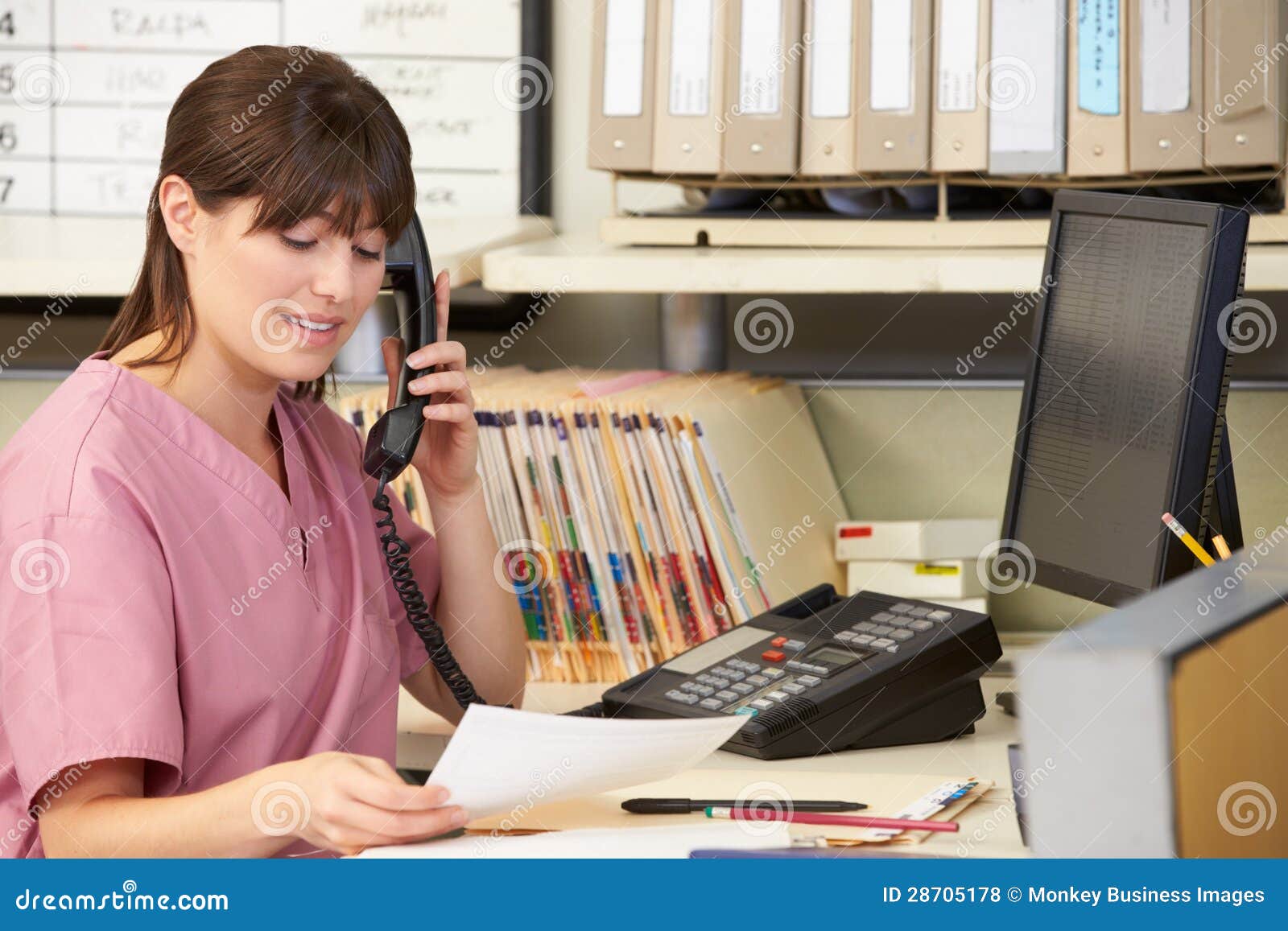 Nurse Making Phone Call at Nurses Station Stock Photo - Image of people ...