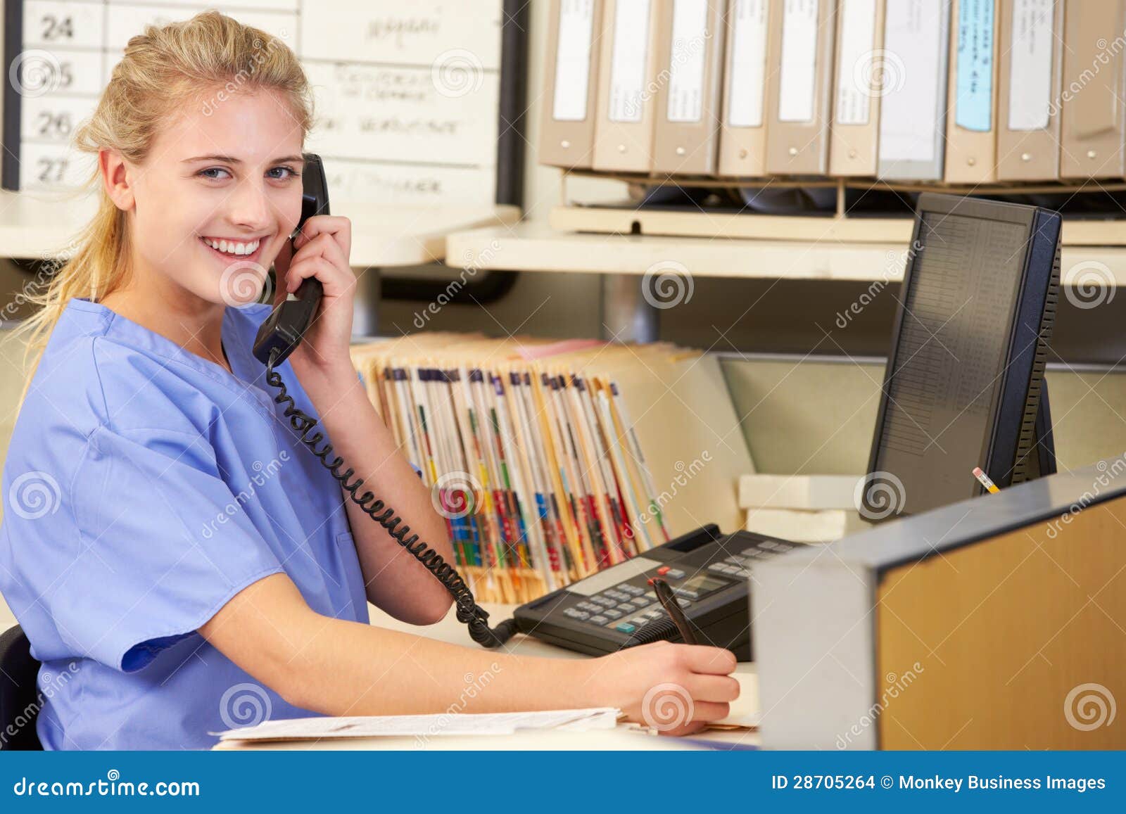 Nurse Making Phone Call at Nurses Station Stock Photo - Image of ...