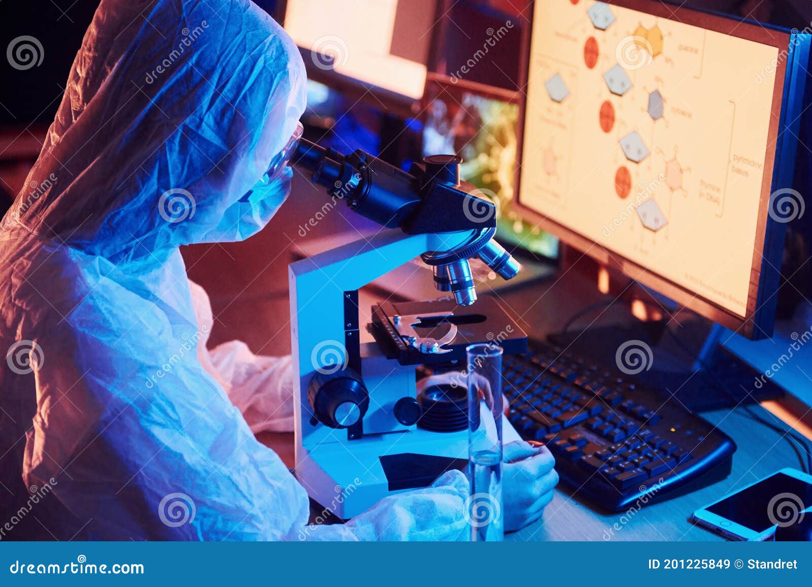 Nurse in Mask and White Uniform Sitting in Neon Lighted Laboratory with ...