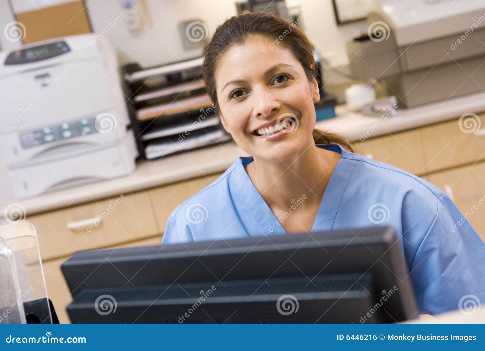 A Nurse Sitting at a Computer Stock Photo - Image of scrubs, confidence ...