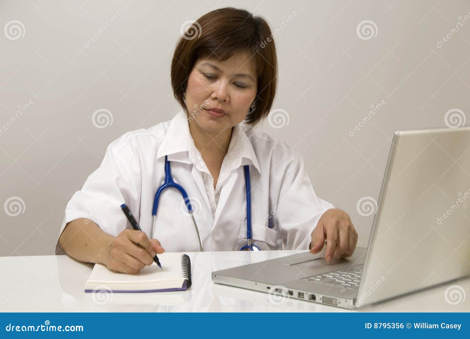 Nurse sitting and writing stock photo. Image of crossed - 8795356