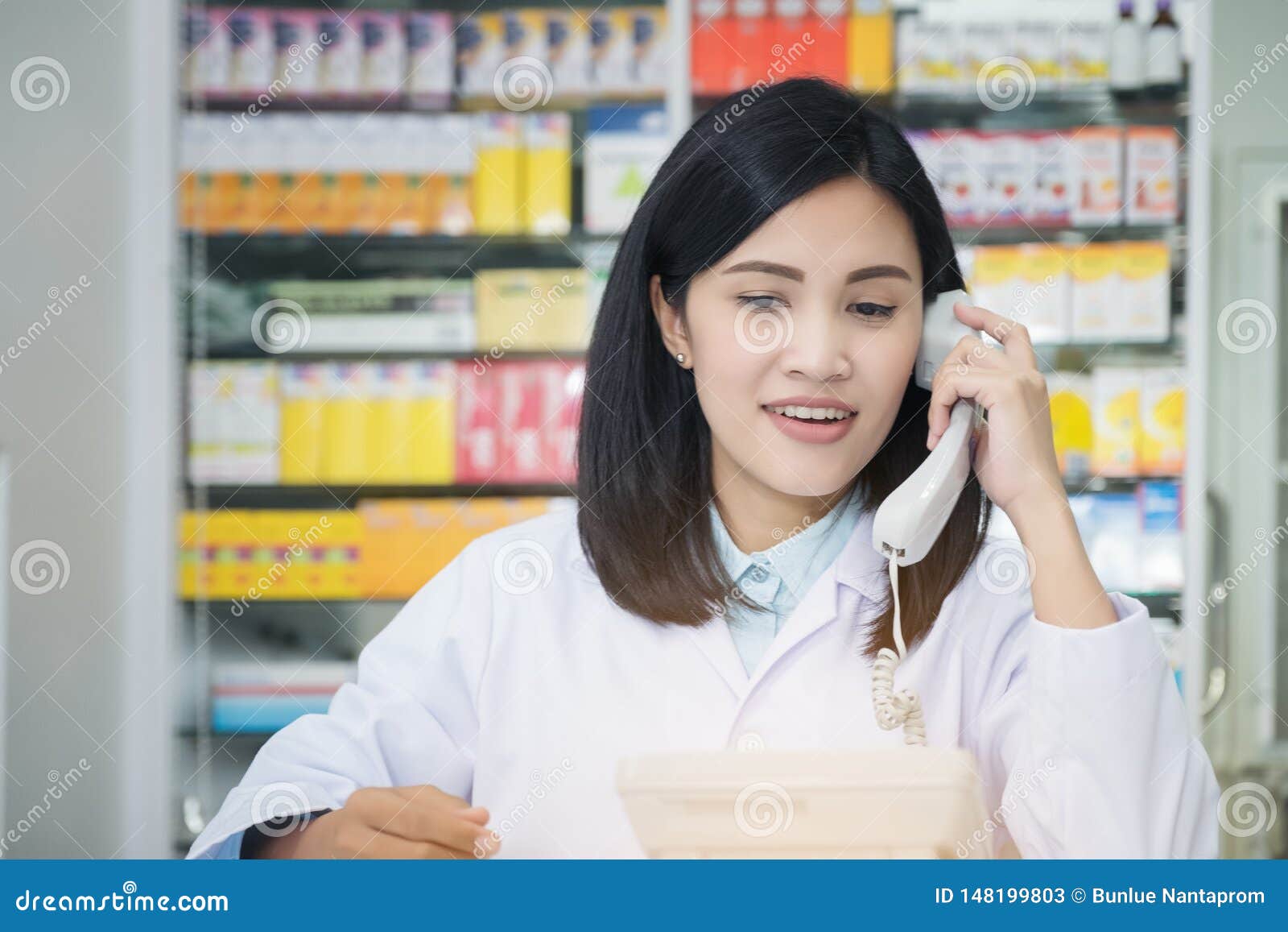 Pharmacy Worker Talking by Phone, Attractive Young Smiling Female at ...