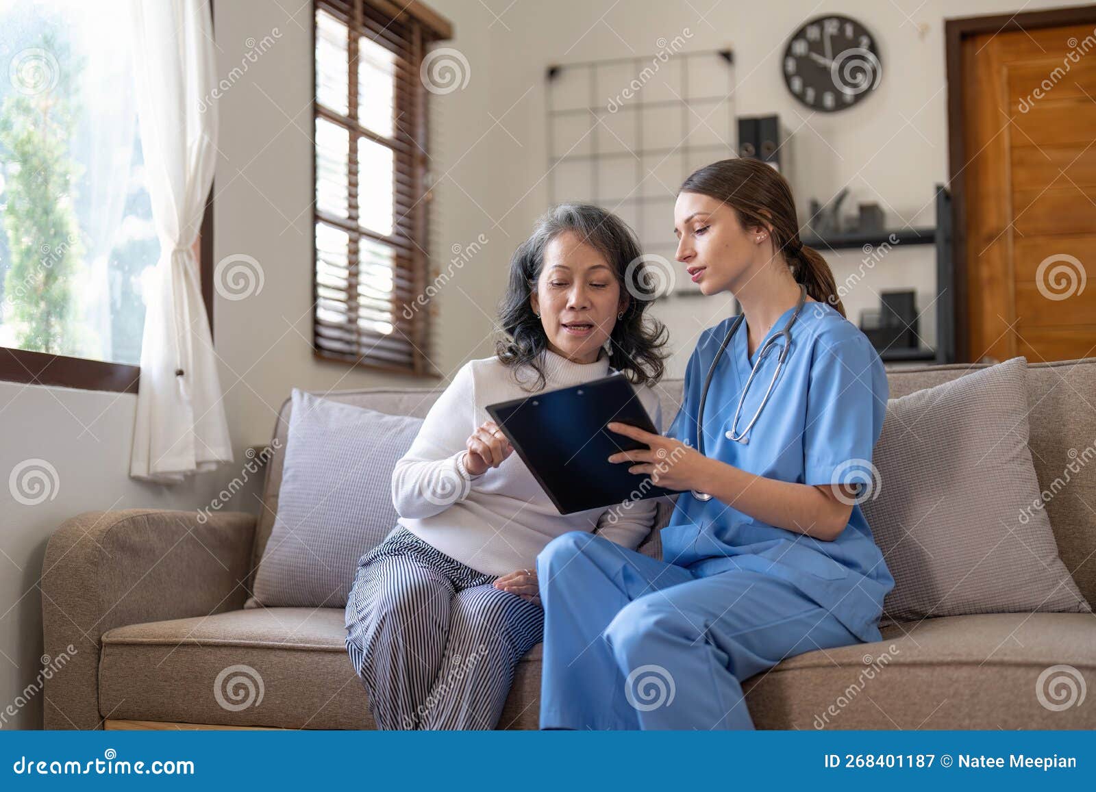 Nurse Taking Notes during Home Visit with Senior Female Patient Stock ...