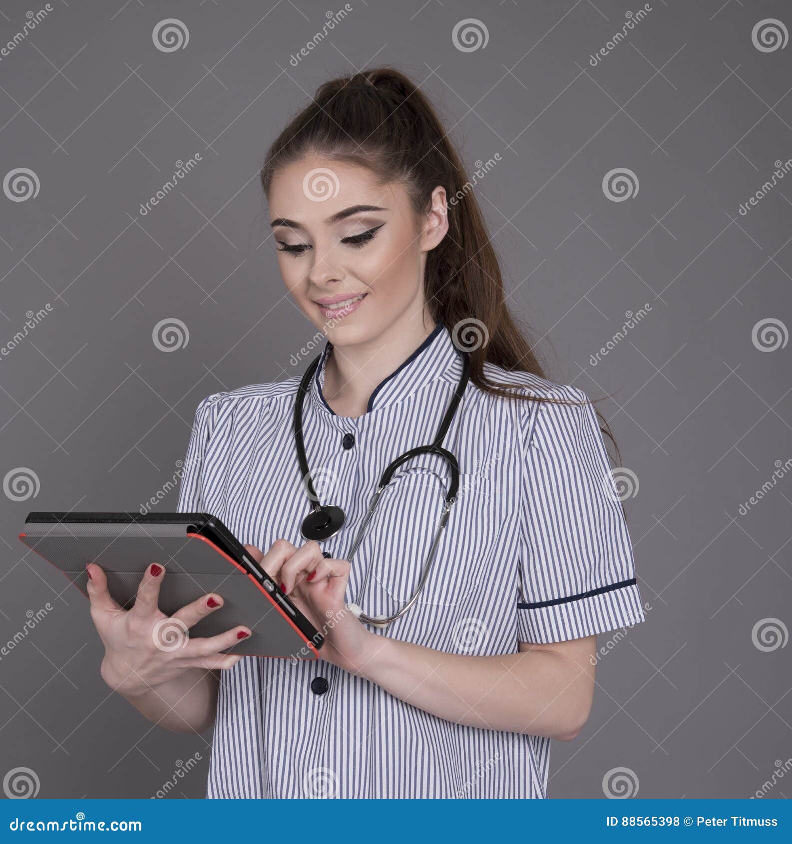 Nurse in Uniform Checking Information on a Tablet Stock Photo - Image ...
