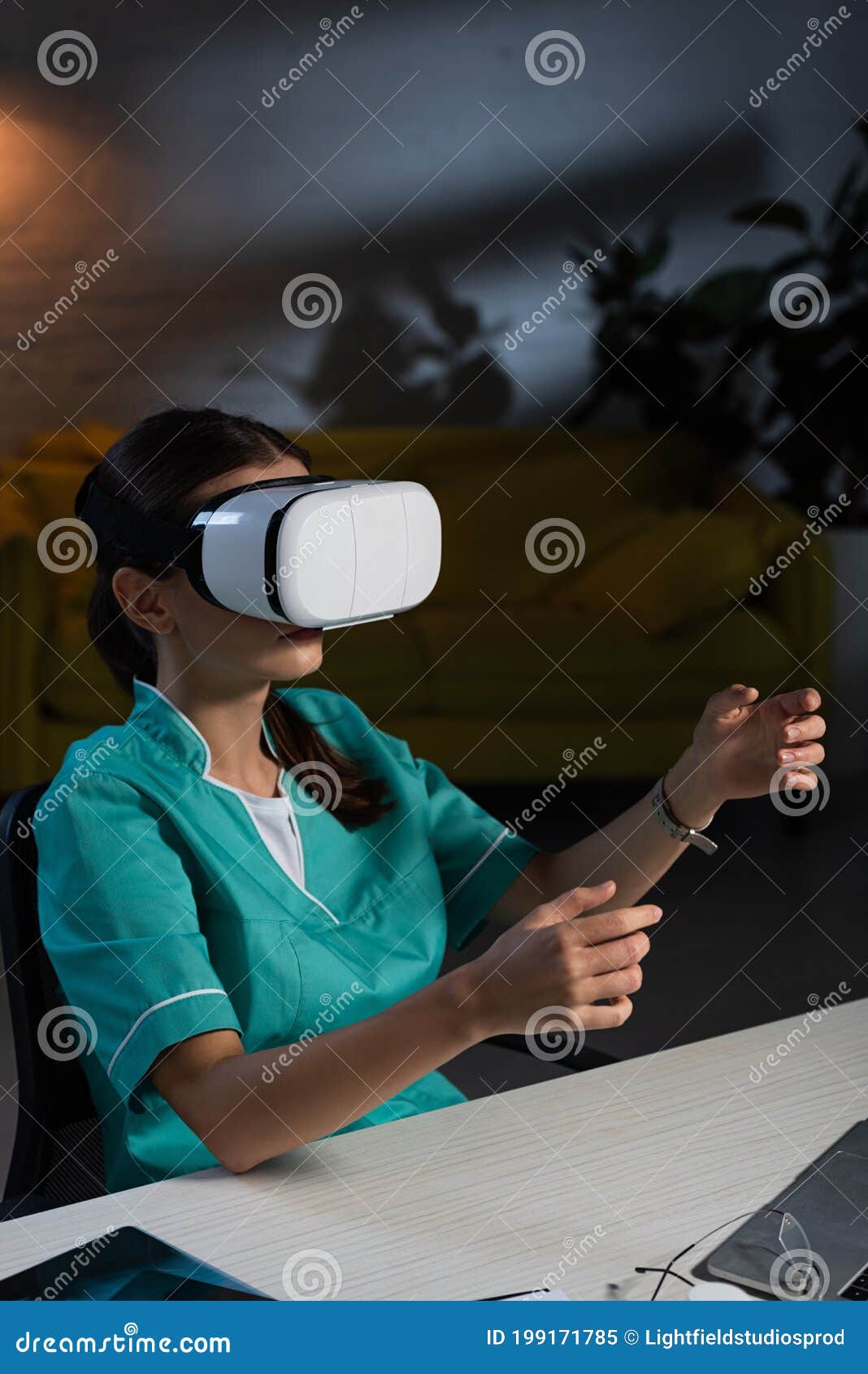Nurse in Uniform Sitting at Table with Virtual Reality Headset Stock ...