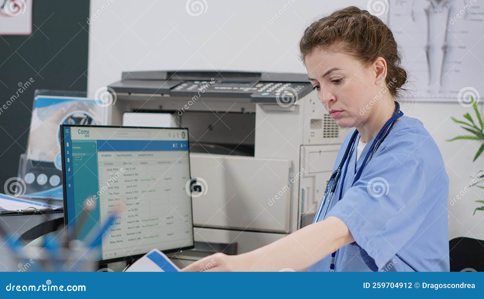 Nurse Using Computer with Appointments at Reception Desk Stock Photo ...