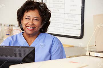 Nurse Using Computer at Nurses Station Stock Photo - Image of american ...