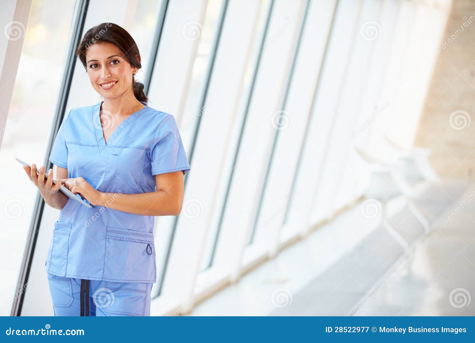 Nurse Using Digital Tablet in Corridor of Modern Hospital Stock Image ...