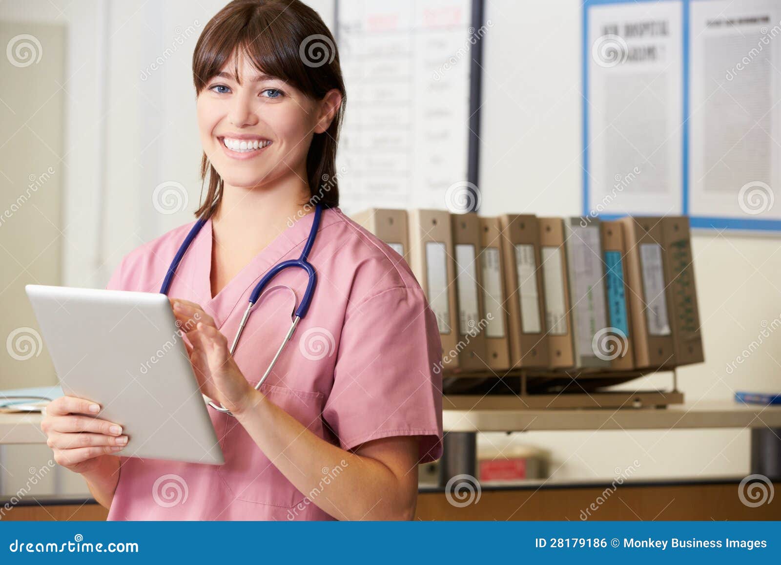 Nurse Using Digital Tablet at Nurses Station Stock Photo - Image of ...