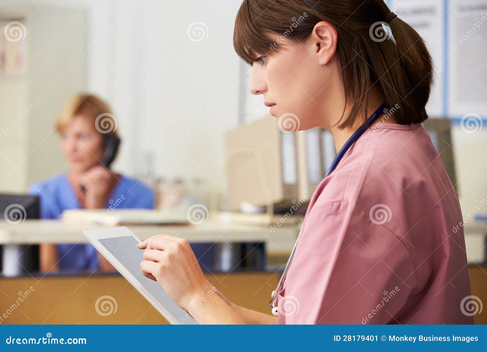 Nurse Using Digital Tablet at Nurses Station Stock Image - Image of ...