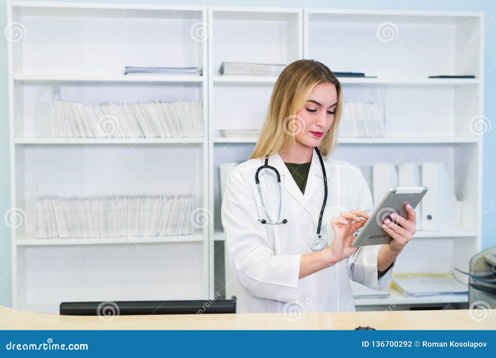 Nurse Using Digital Tablet in Reception of Modern Hospital Stock Photo ...