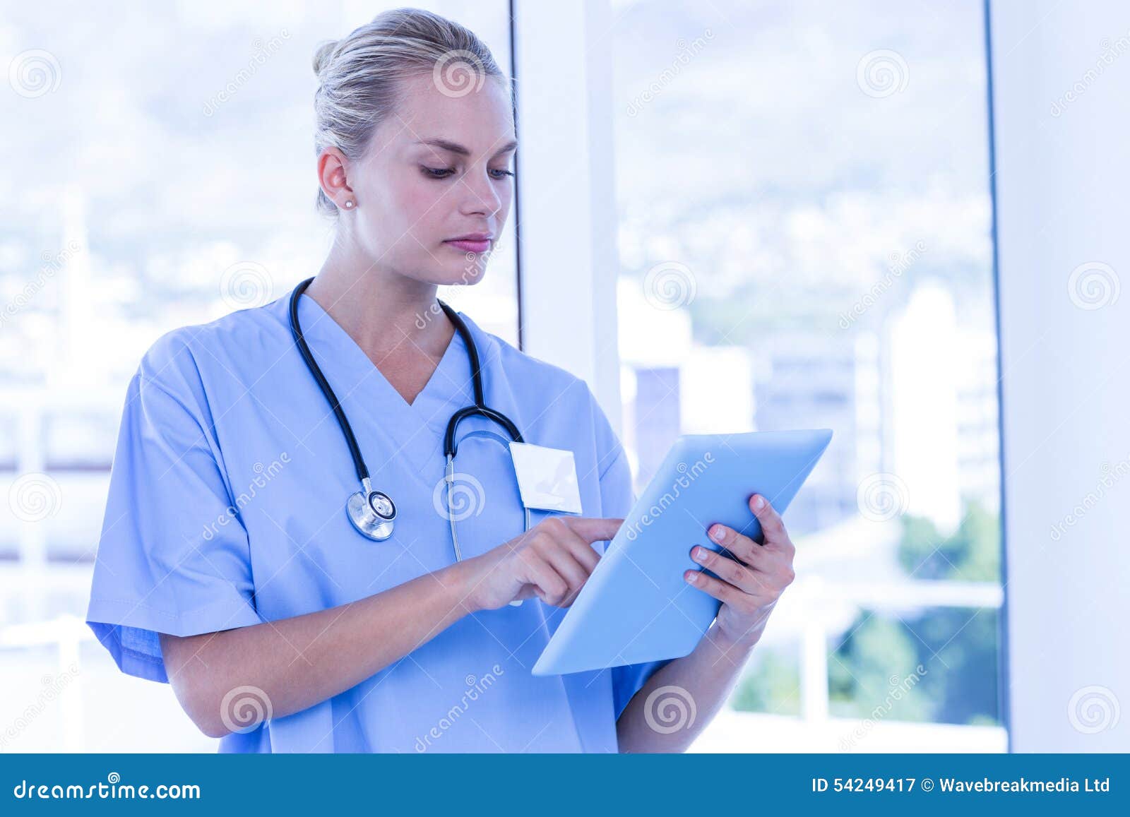 Nurse using her tablet pc stock image. Image of expertise - 54249417