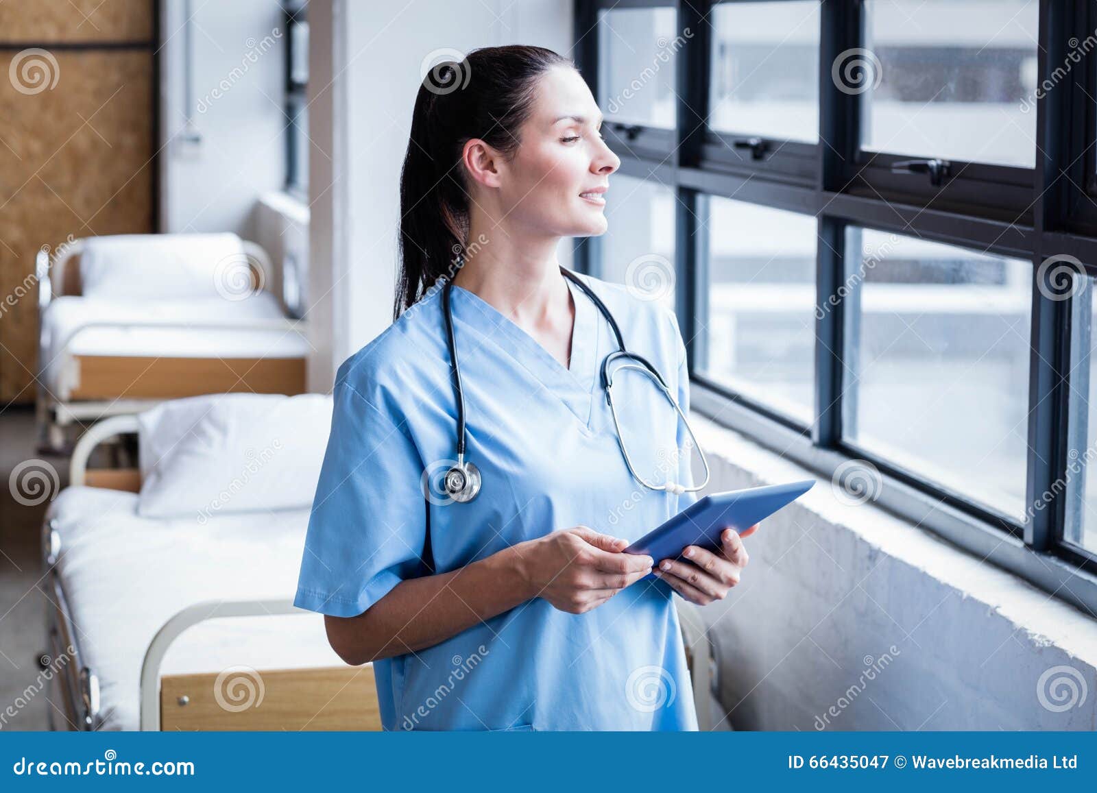 Nurse using her tablet pc stock image. Image of woman - 66435047
