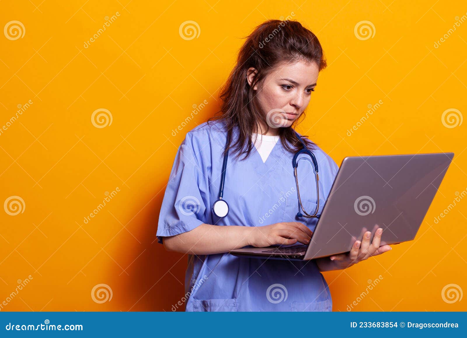 Nurse Using Technology on Modern Laptop and Wearing Uniform Stock Photo ...