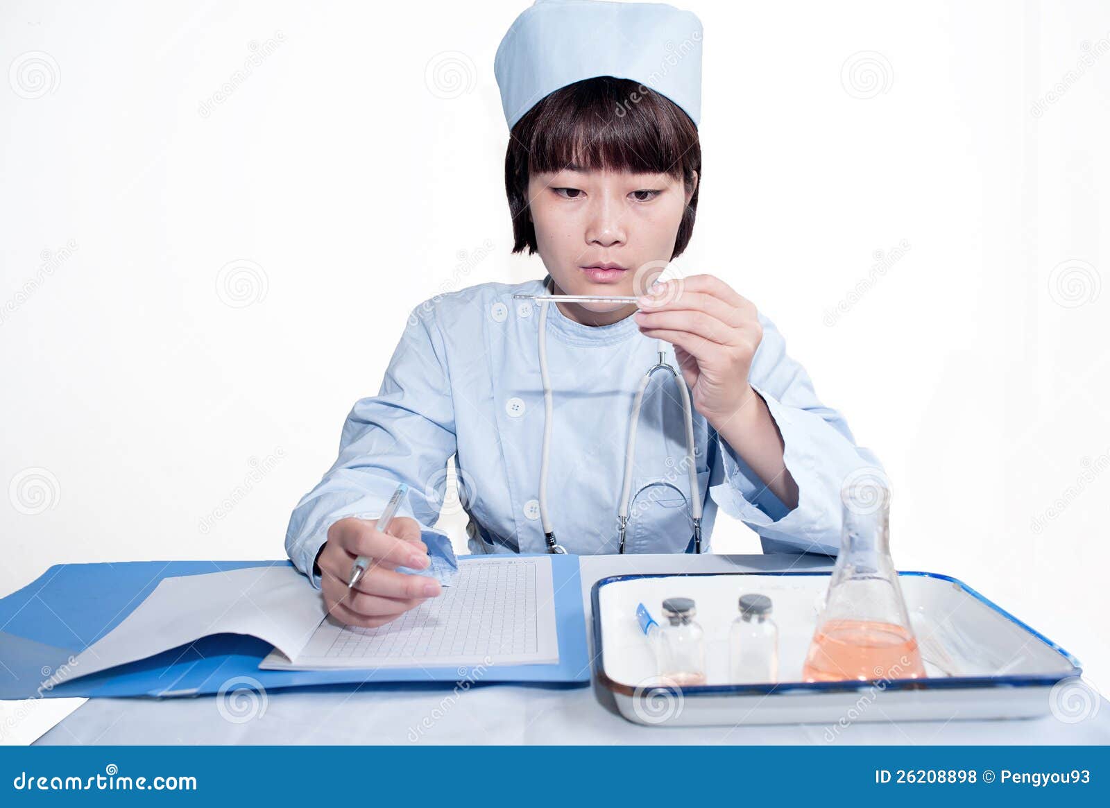 The Nurse at Work Looking at Thermometer Stock Photo - Image of ...