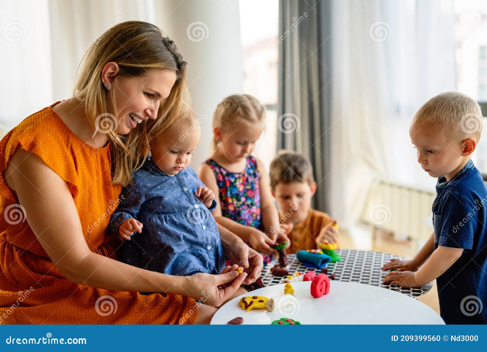 Nursery Children Having Fun and Playing with Teachers. Stock Photo ...