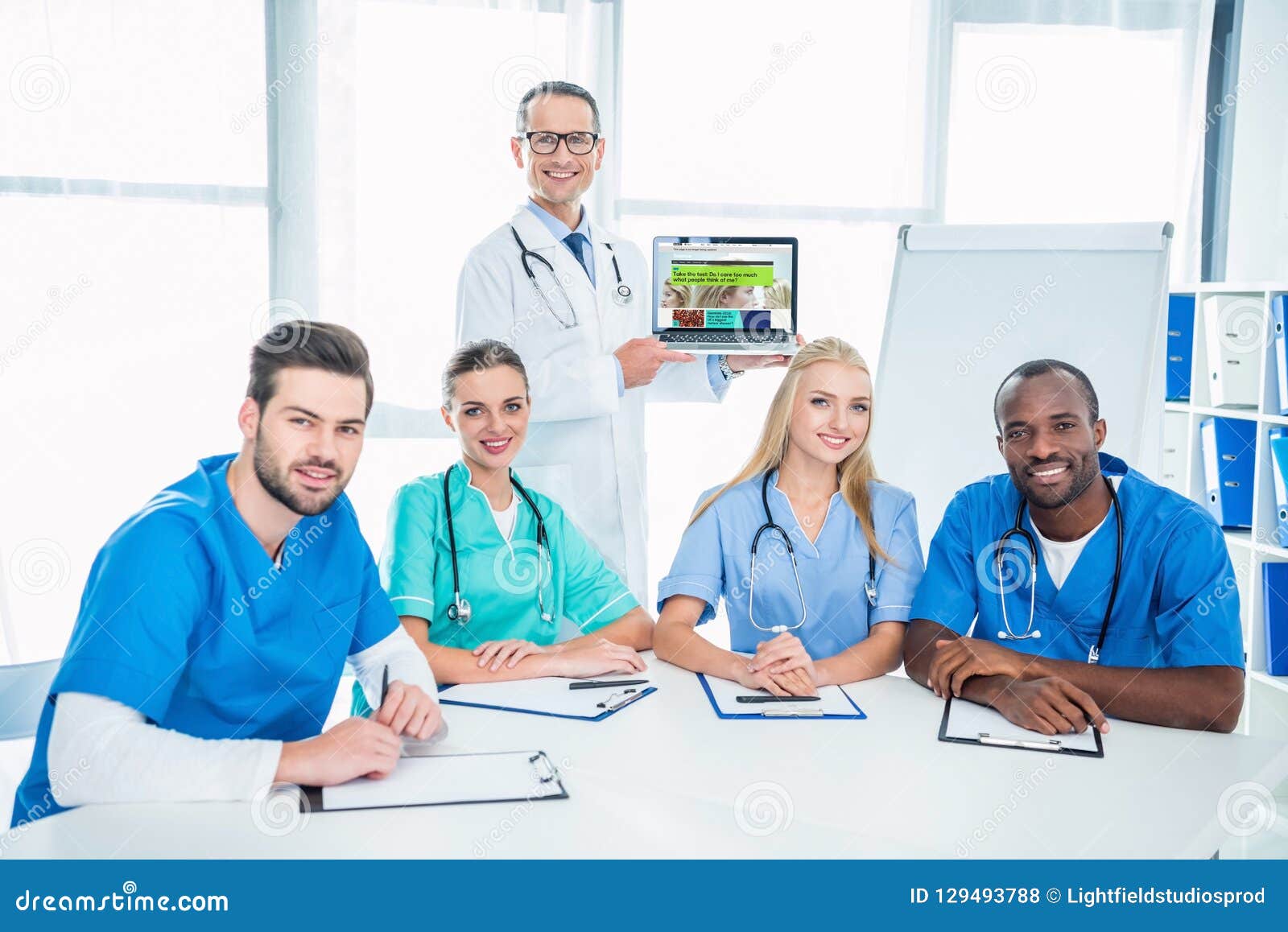 Team of Male and Female Nurses and General Practitioner with Laptop ...