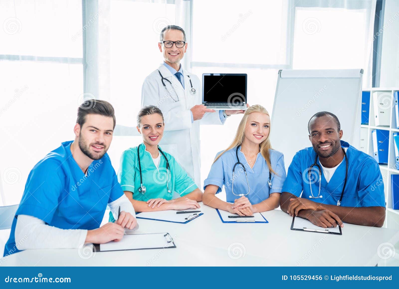 Nurses and General Practitioner with Laptop Stock Photo - Image of team ...