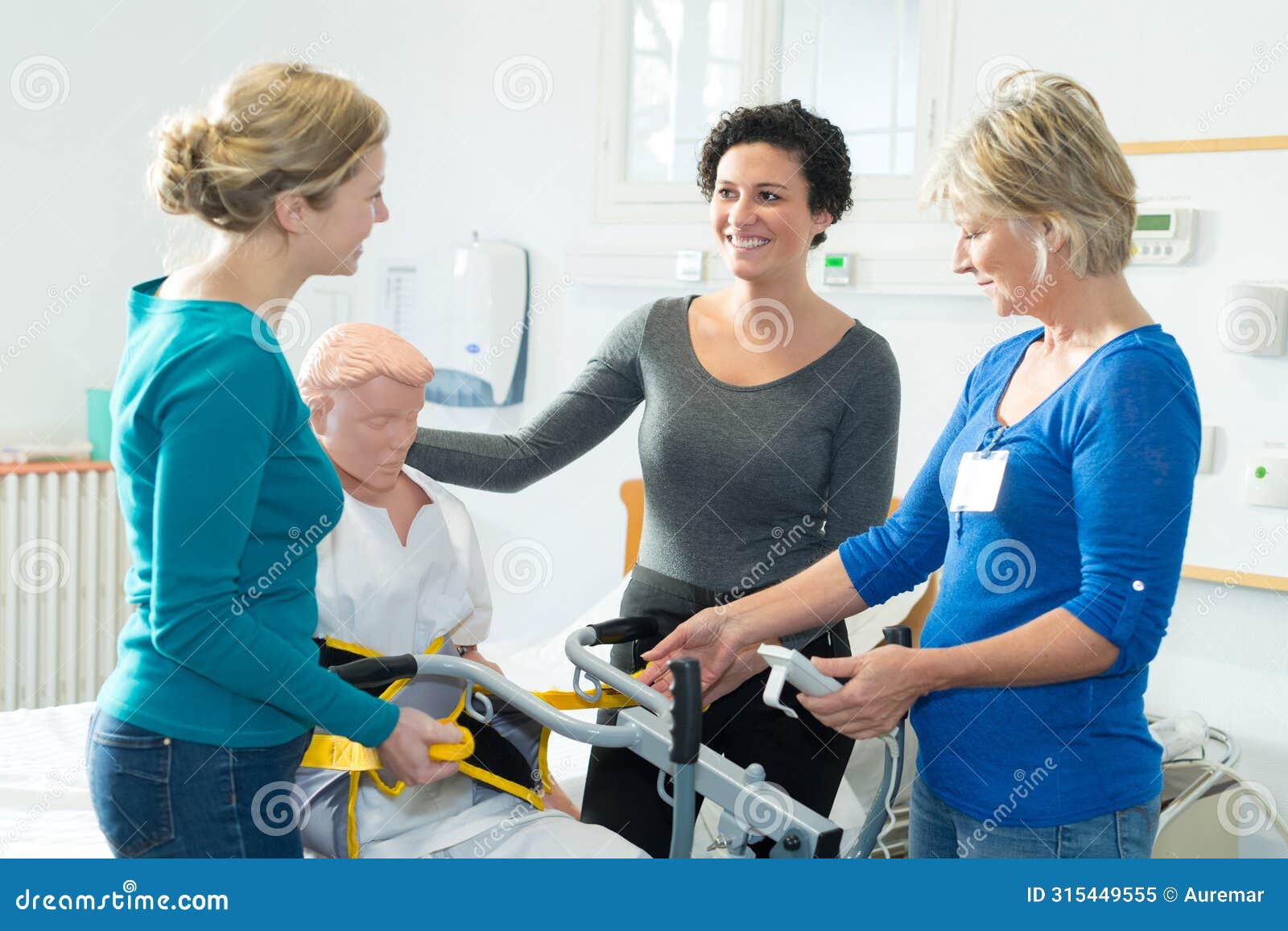 Nurses Practicing Procedure To Lift Disabled Patient from Bed Stock ...