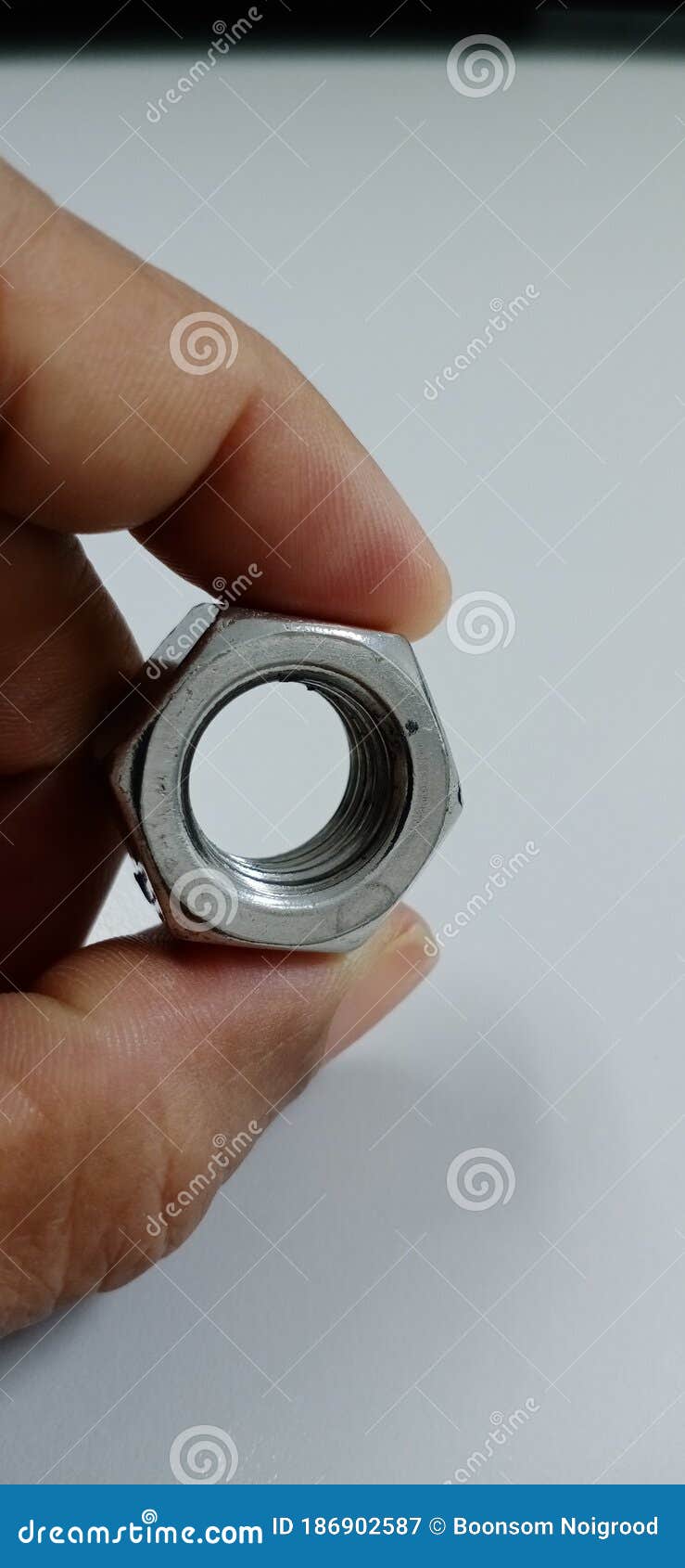 A nut in a hand stock image. Image of steel, metal, holding - 186902587