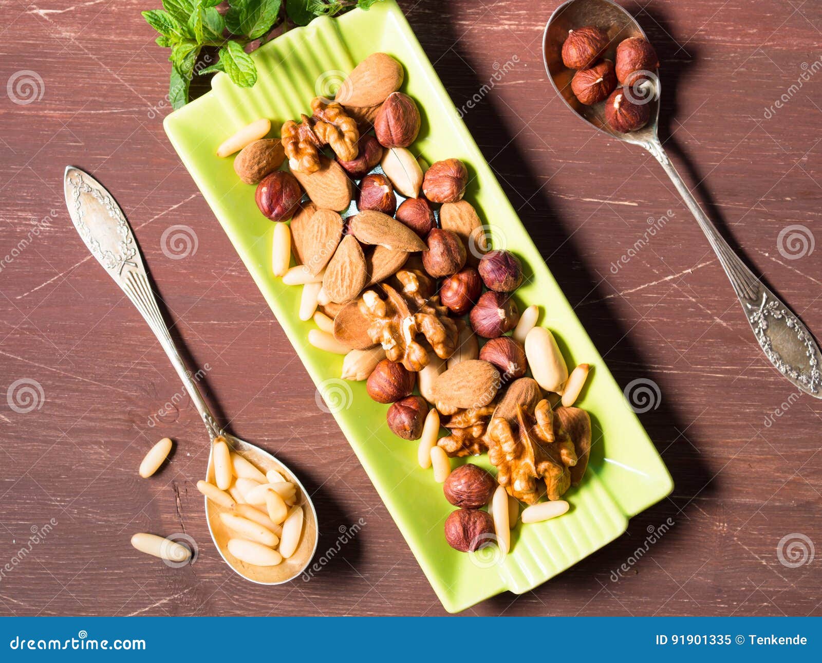 Nut mix on green dish stock image. Image of peanut, spoon - 91901335