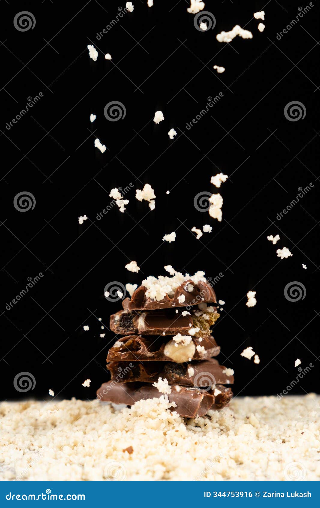 Nut Shavings Pouring on Milk Chocolate on a Black Background. Stock ...