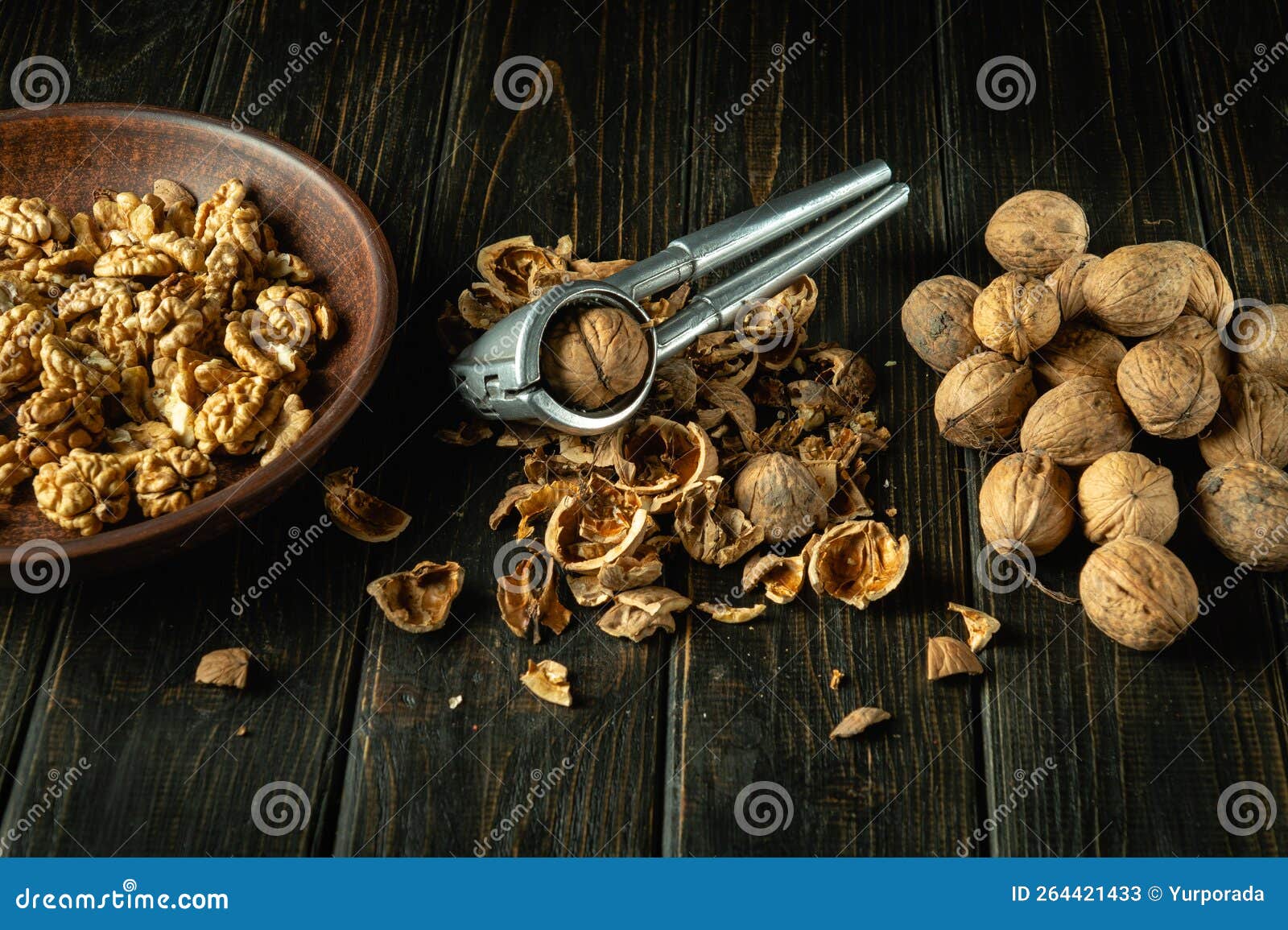 Nutcracker on a Vintage Black Table with a Bunch of Nuts and Husks ...