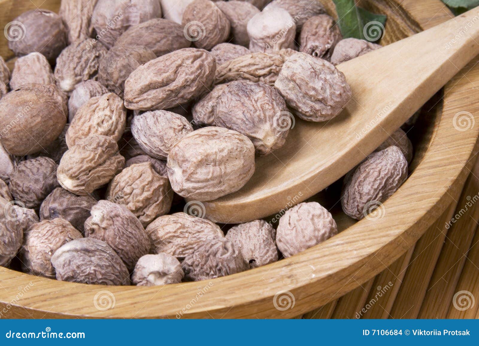 Nutmeg in wooden plate stock photo. Image of food, spicery - 7106684