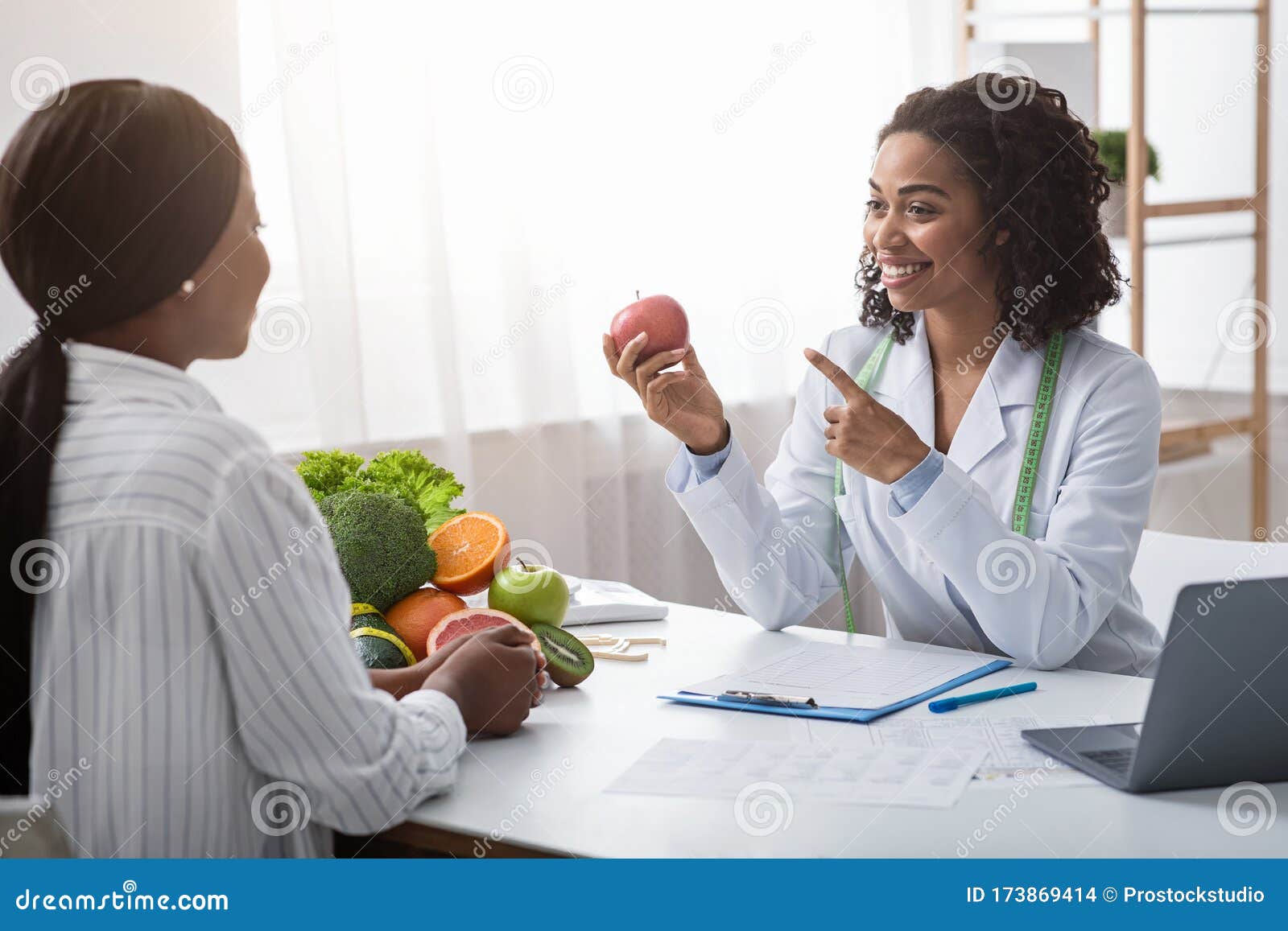 Nutritionist Giving Consultation To Patient With Healthy Fruit And