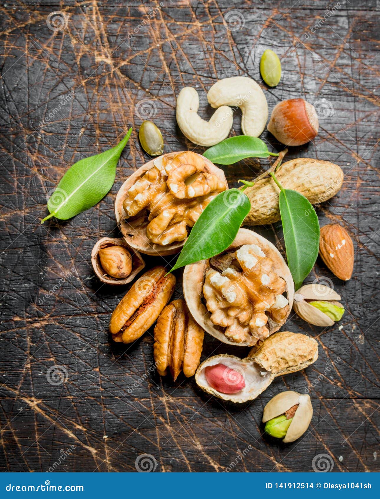 Nuts Background. Assortment of Different Nuts with Green Leaves Stock ...