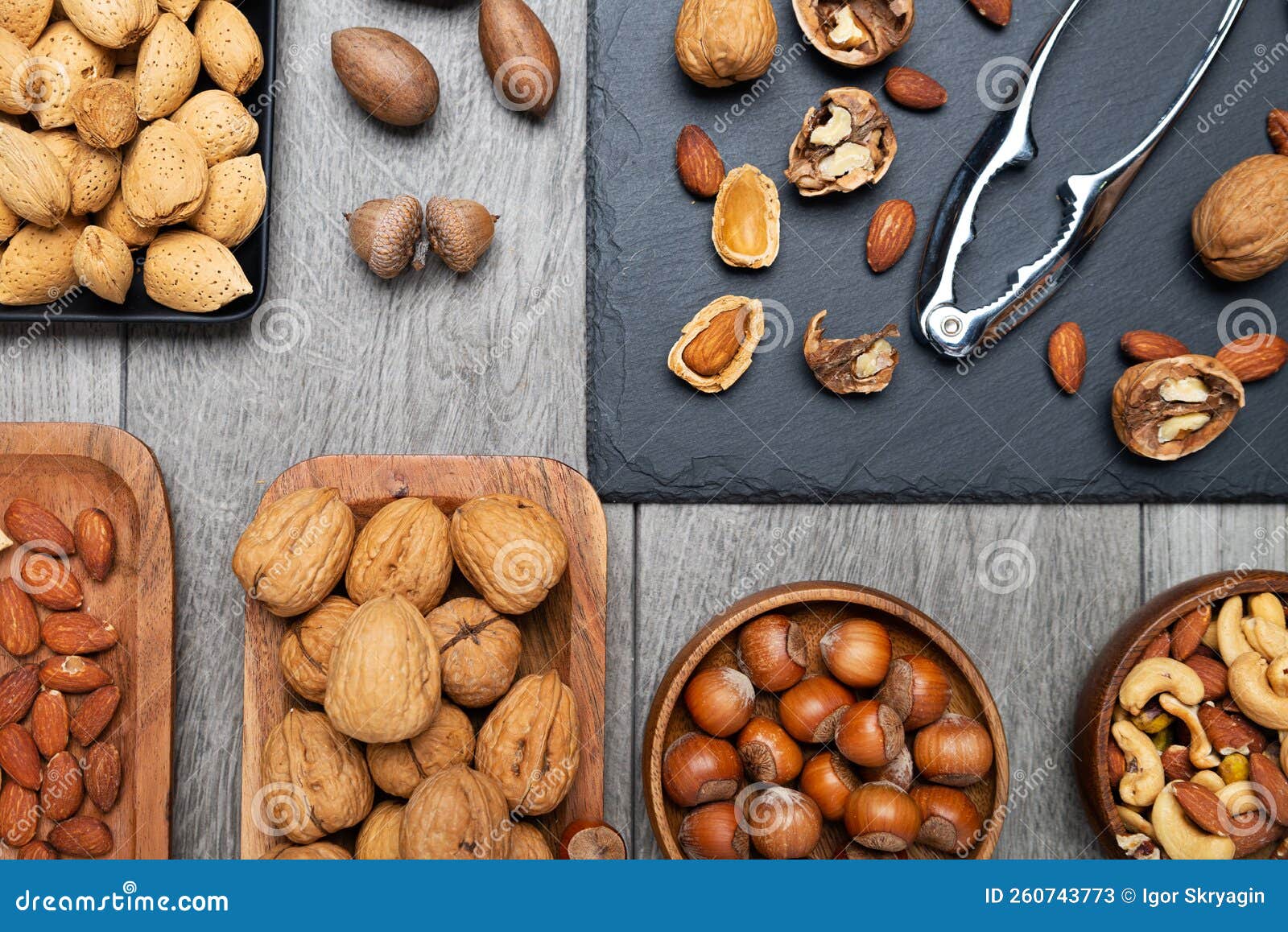 Nuts in Bowls and a Nutcracker on a Gray Table. Top View, Assortment of ...