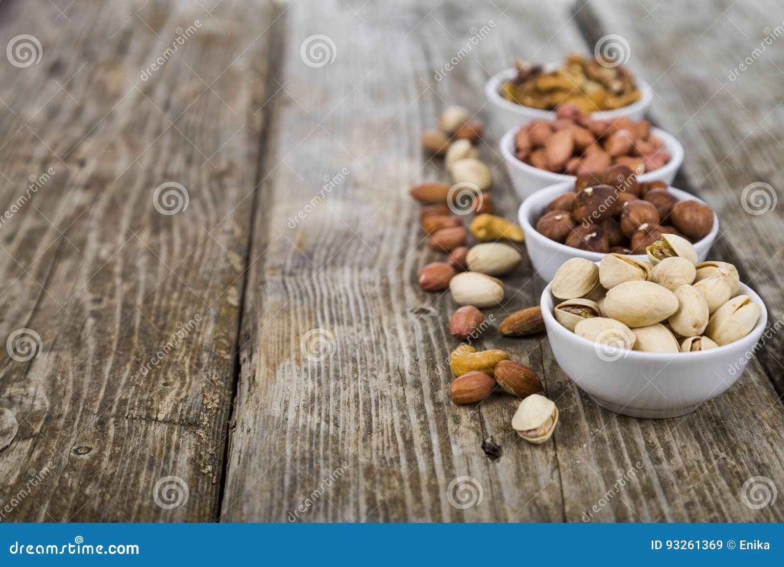 Nuts in a Plate on a Wooden Table. Stock Image - Image of objects ...