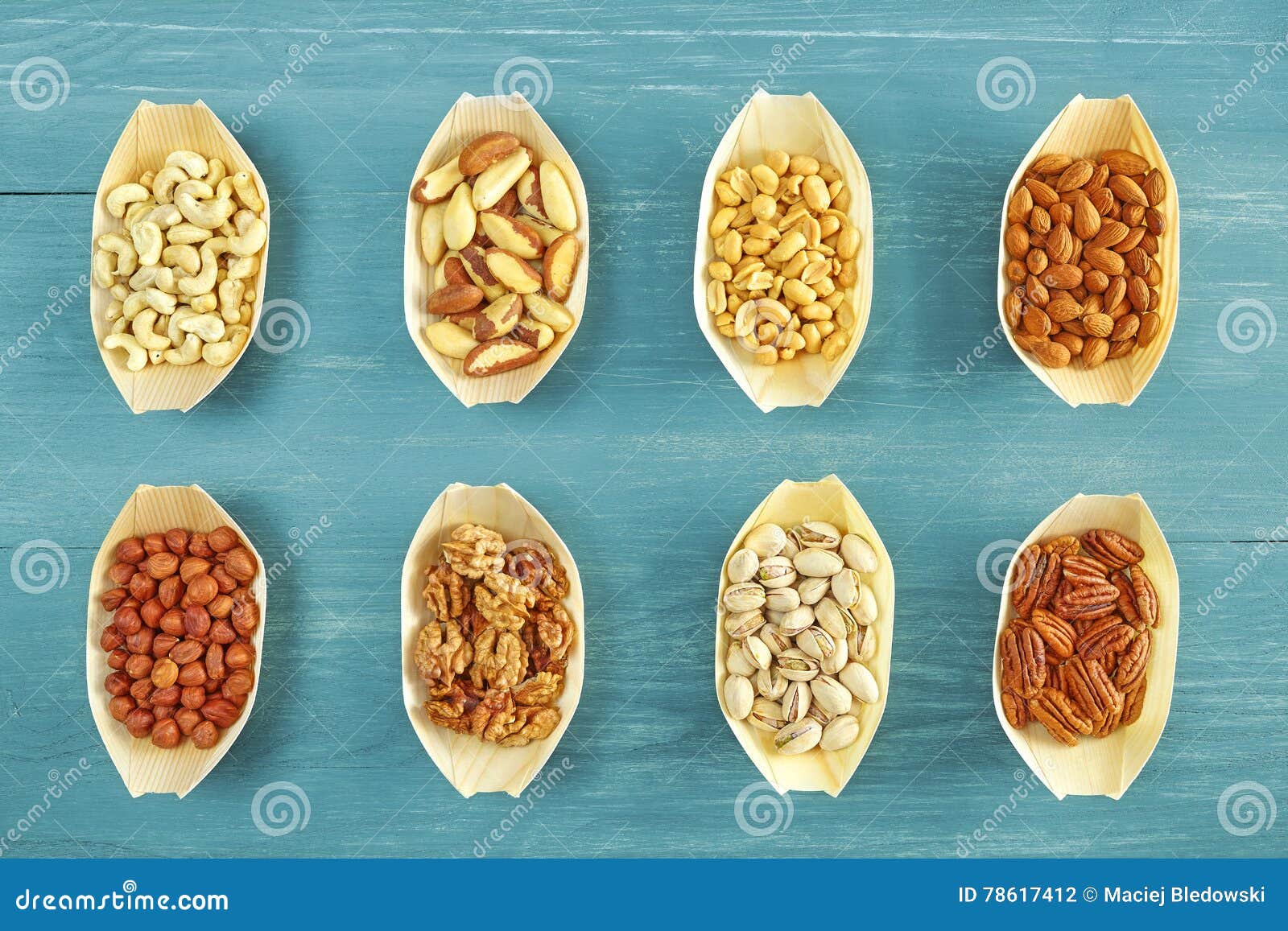 Nuts Selection in Wooden Bowls on Blue Rustic Table. Stock Photo ...
