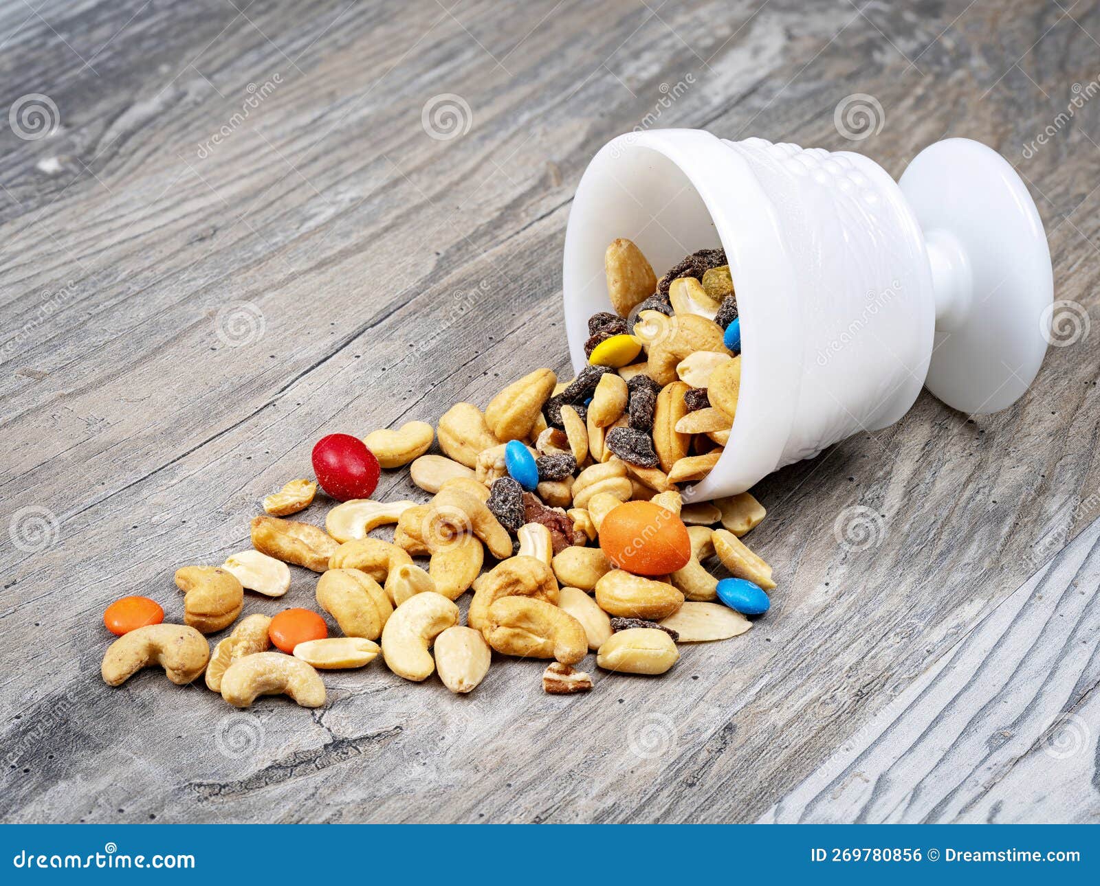 Nuts Spilled Onto a Table Top from a White Container Stock Photo ...