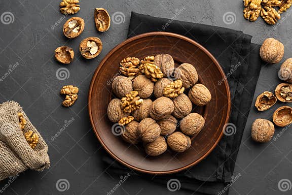 Nuts. Walnut Kernels and Whole Walnuts on Dark Stone Table Stock Photo ...