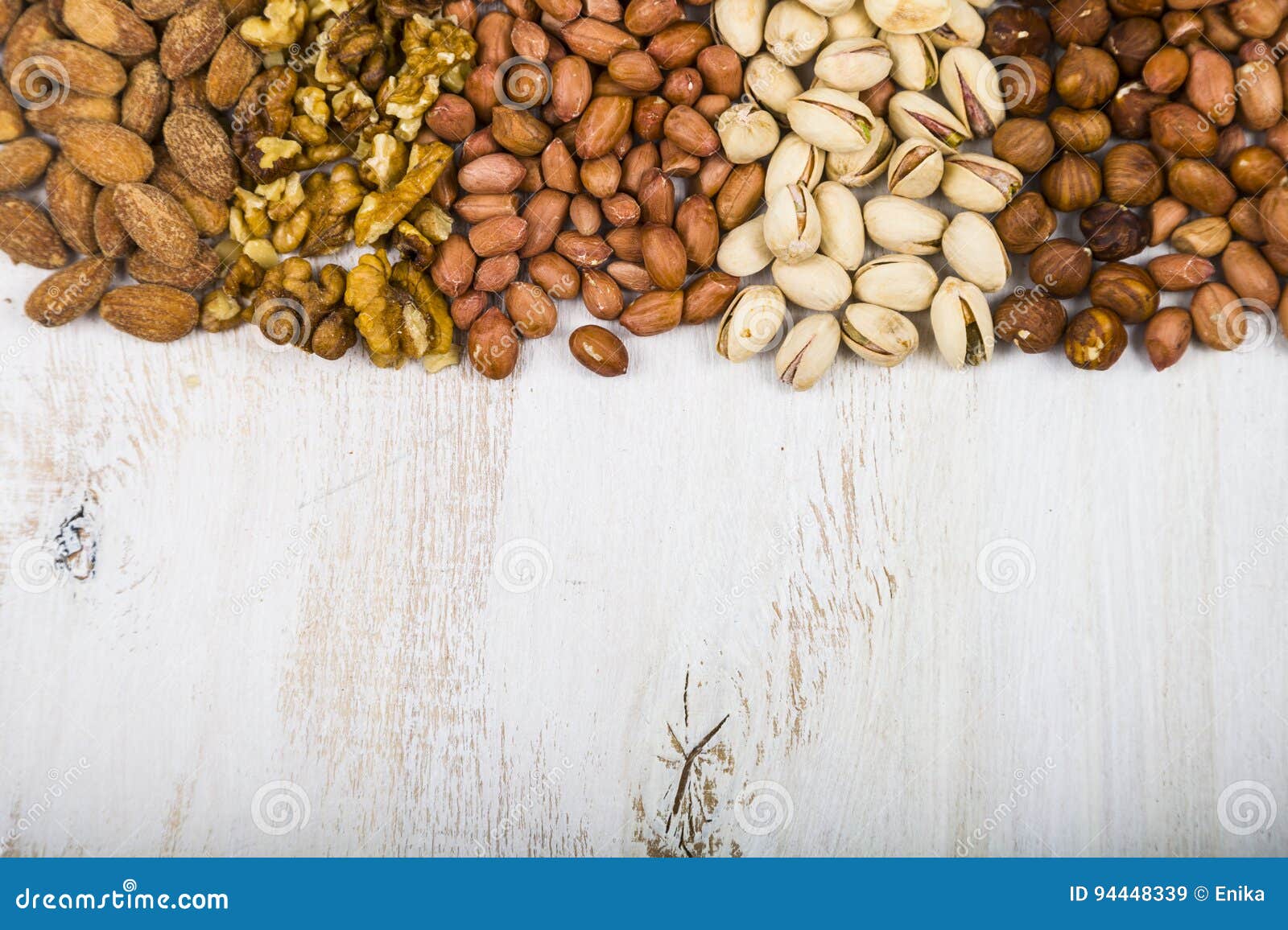 Nuts on a wooden table. stock image. Image of ingredient - 94448339